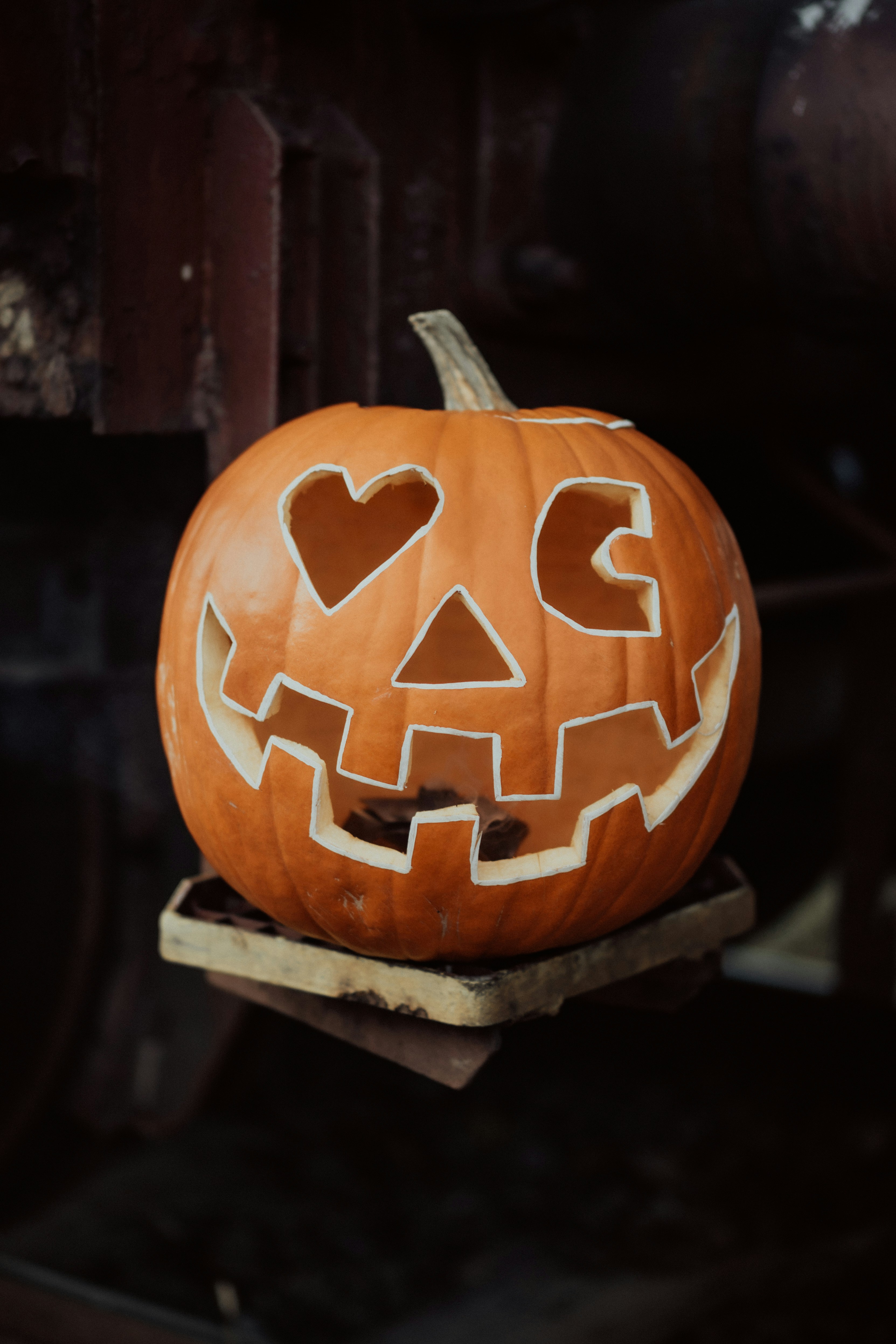 A carved pumpkin sitting on top of a train track photo – Free Halloween ...