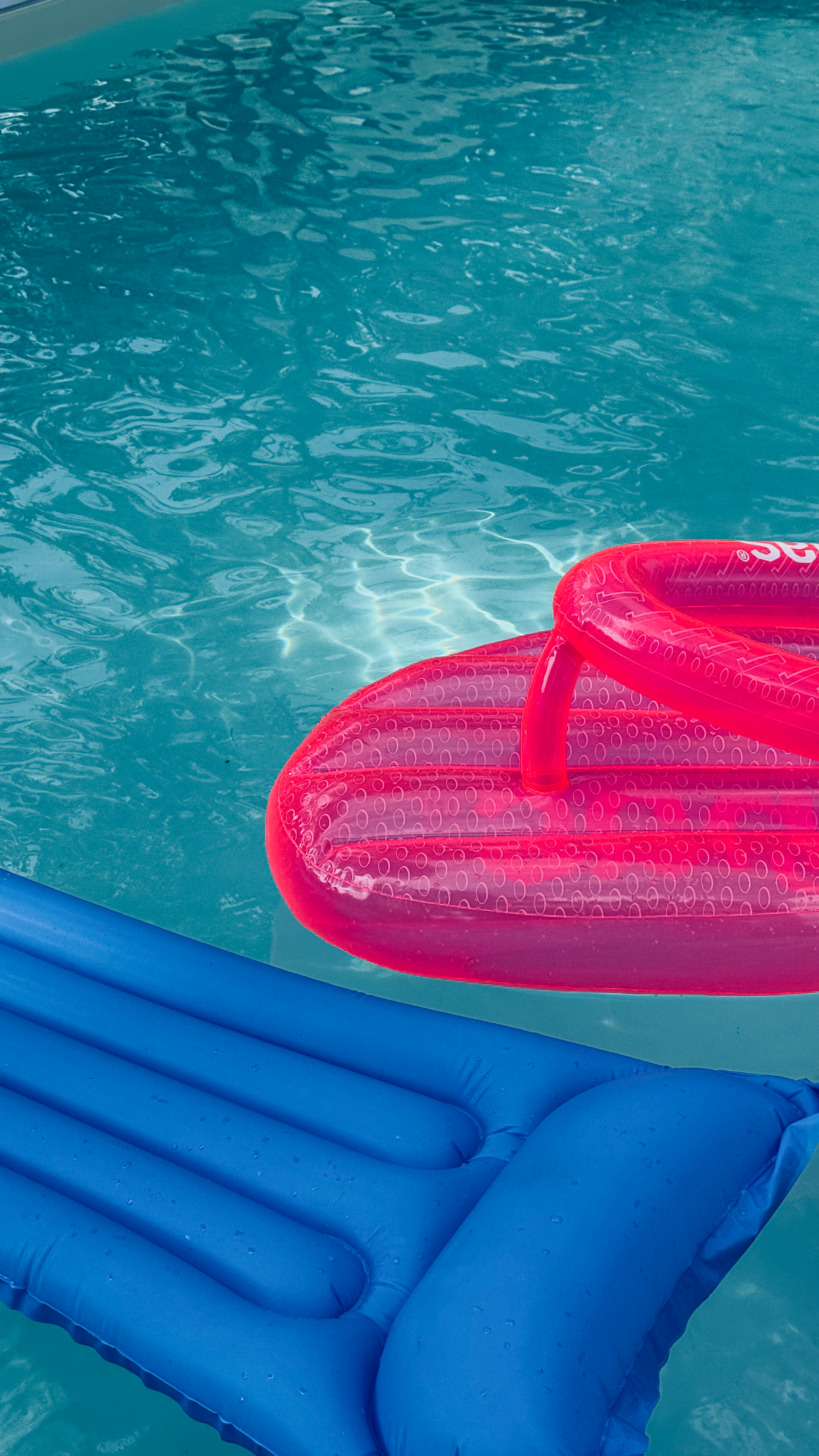 Two inflatable floats floating in a swimming pool photo – Free Summer ...
