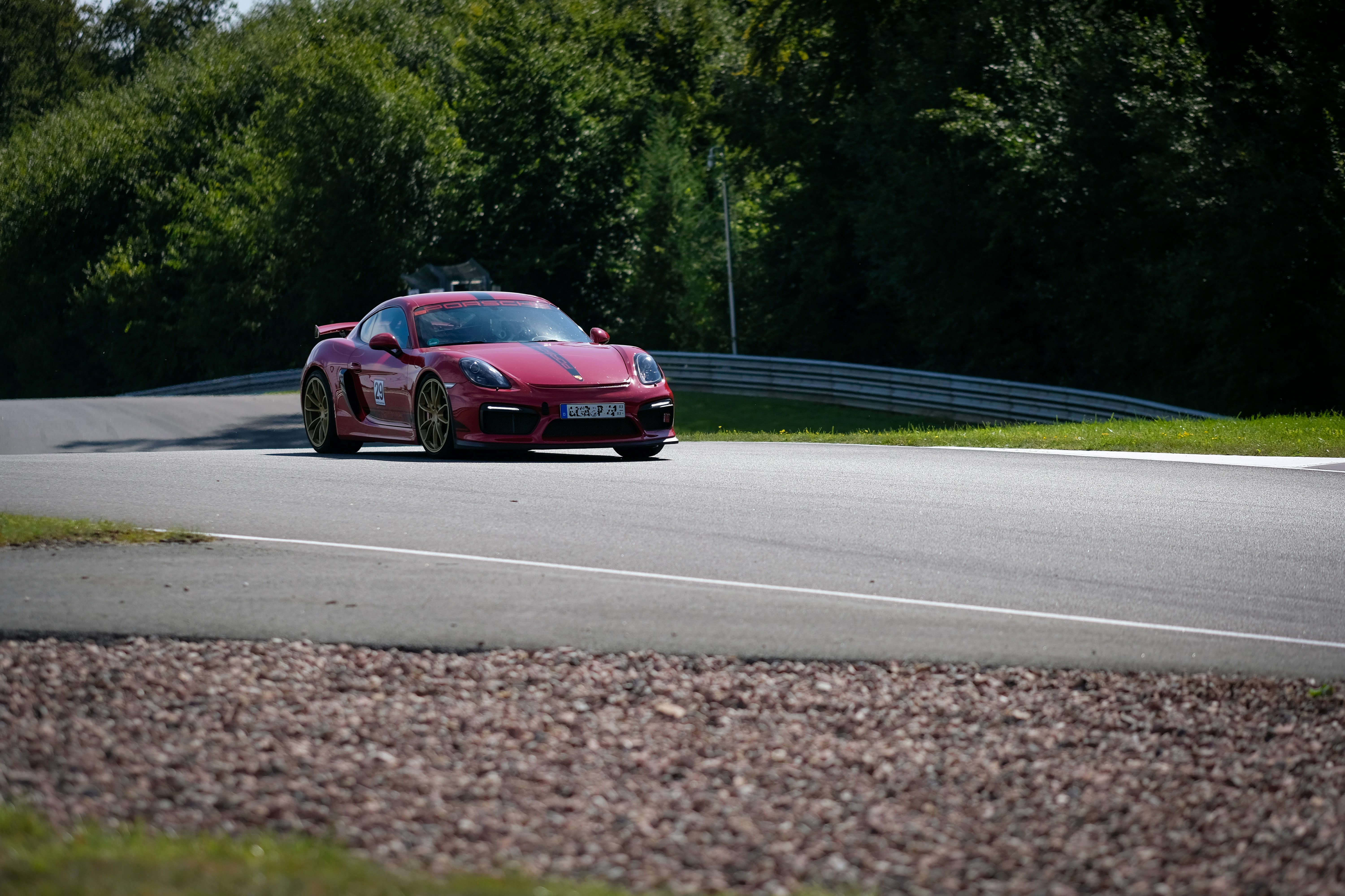 Apex in Red: Porsche Rounds a Quiet Curve on a Sunlit Track