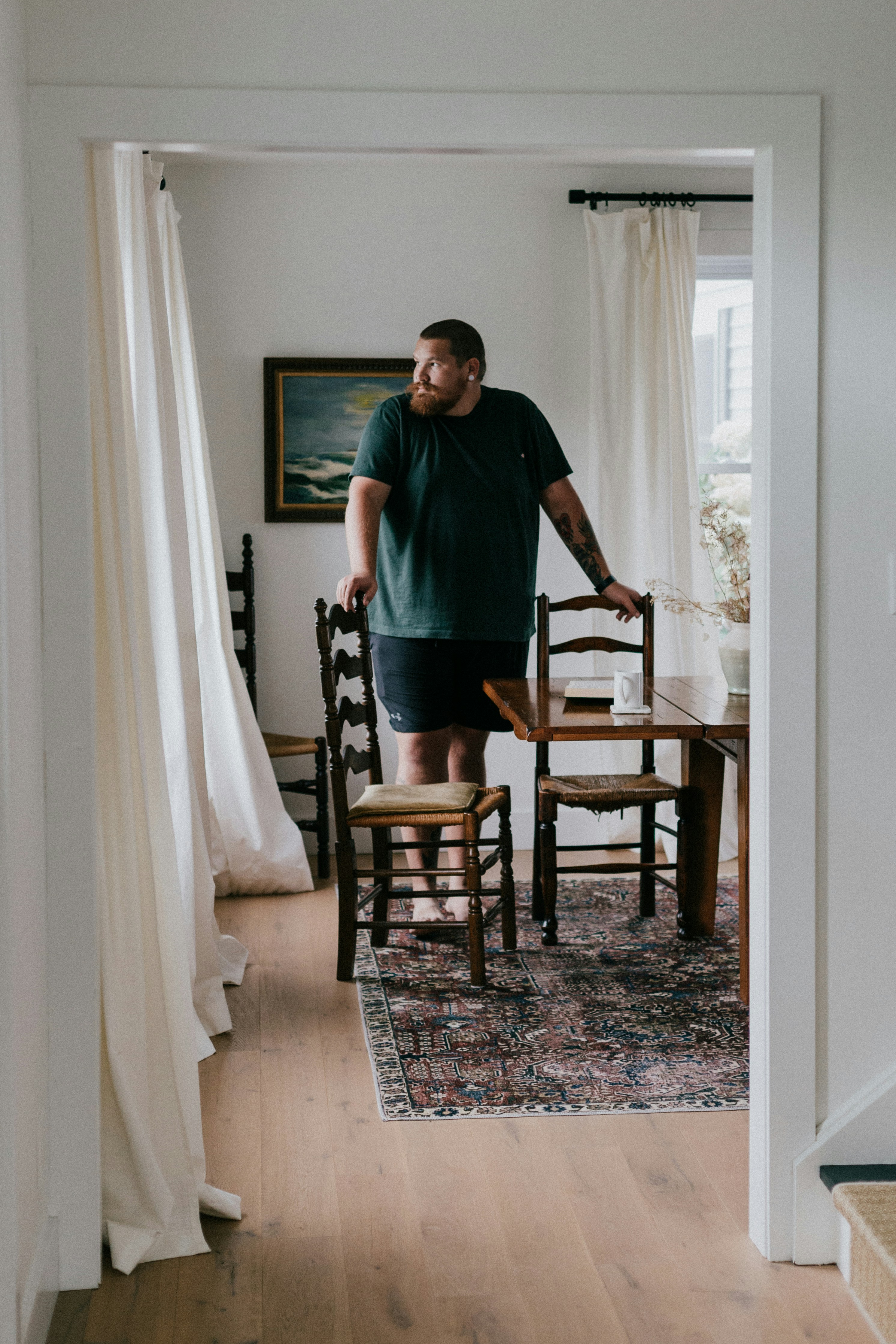 A man standing at a dining room table photo – Free Portrait Image on ...