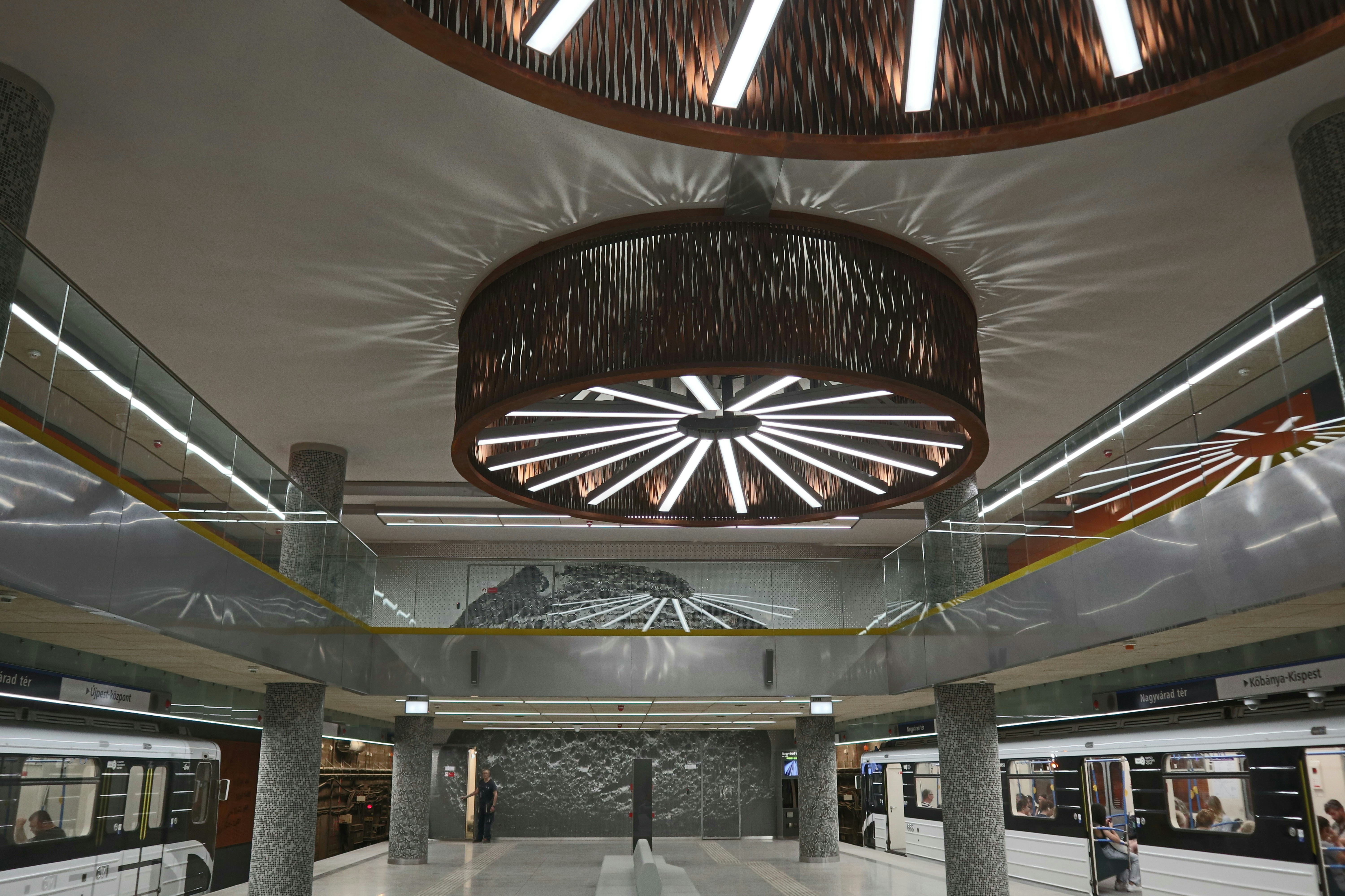 Sunburst Ring Lights Crown a Modern Subway Hall