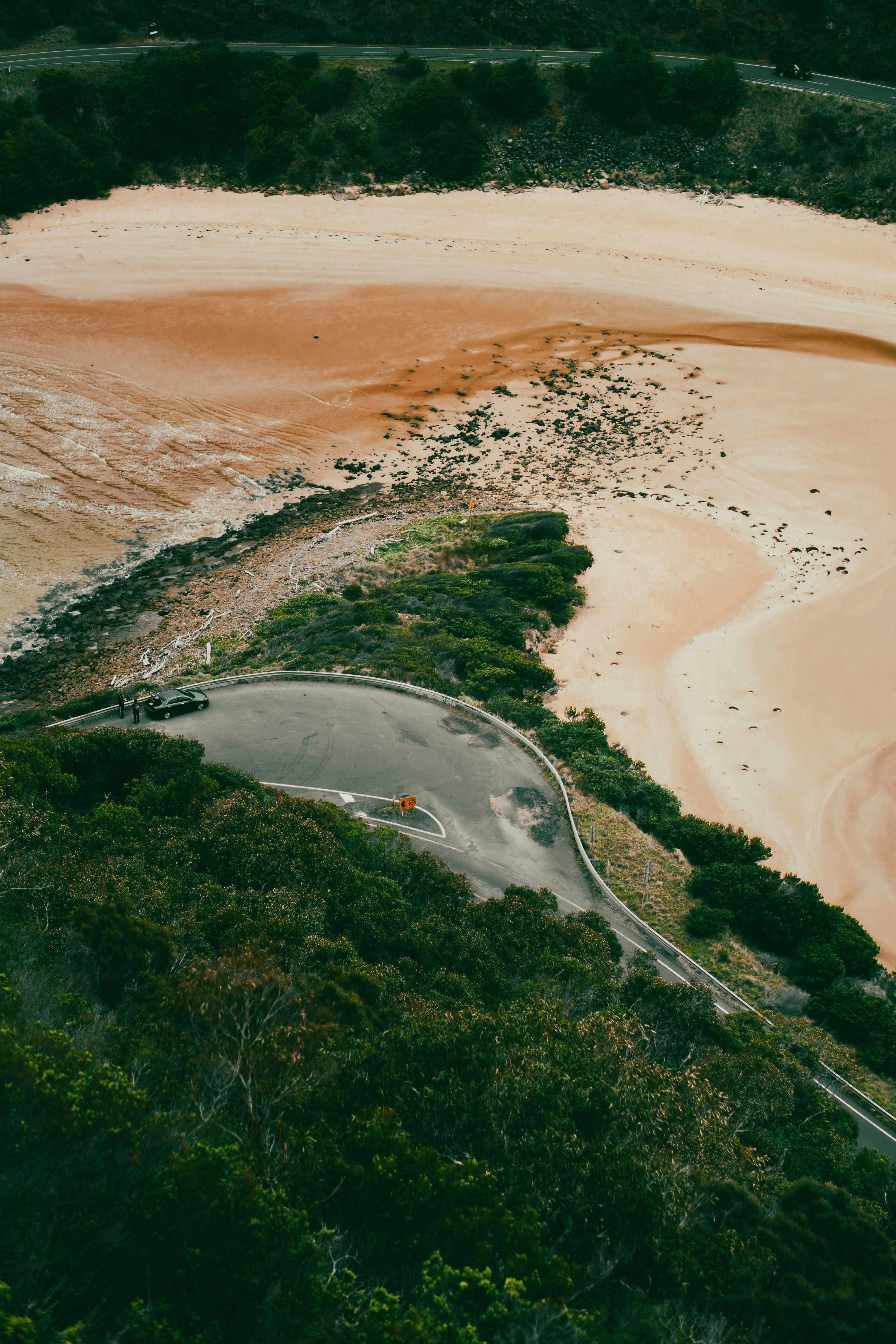 Coastal Ribbon: A Curving Road Nestled Between Beach and Forest