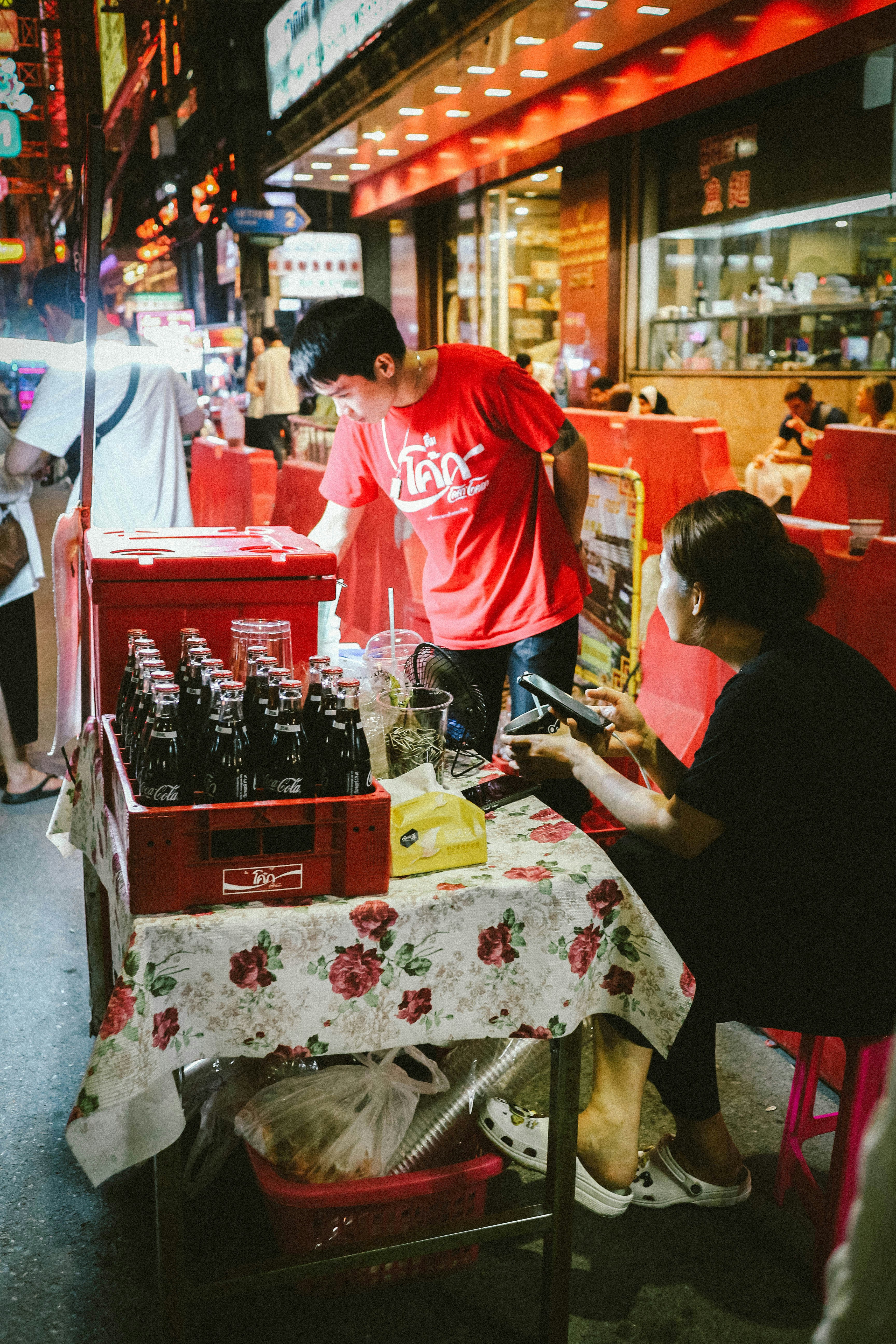 Neon Night Shift at a Bustling Drink Stand