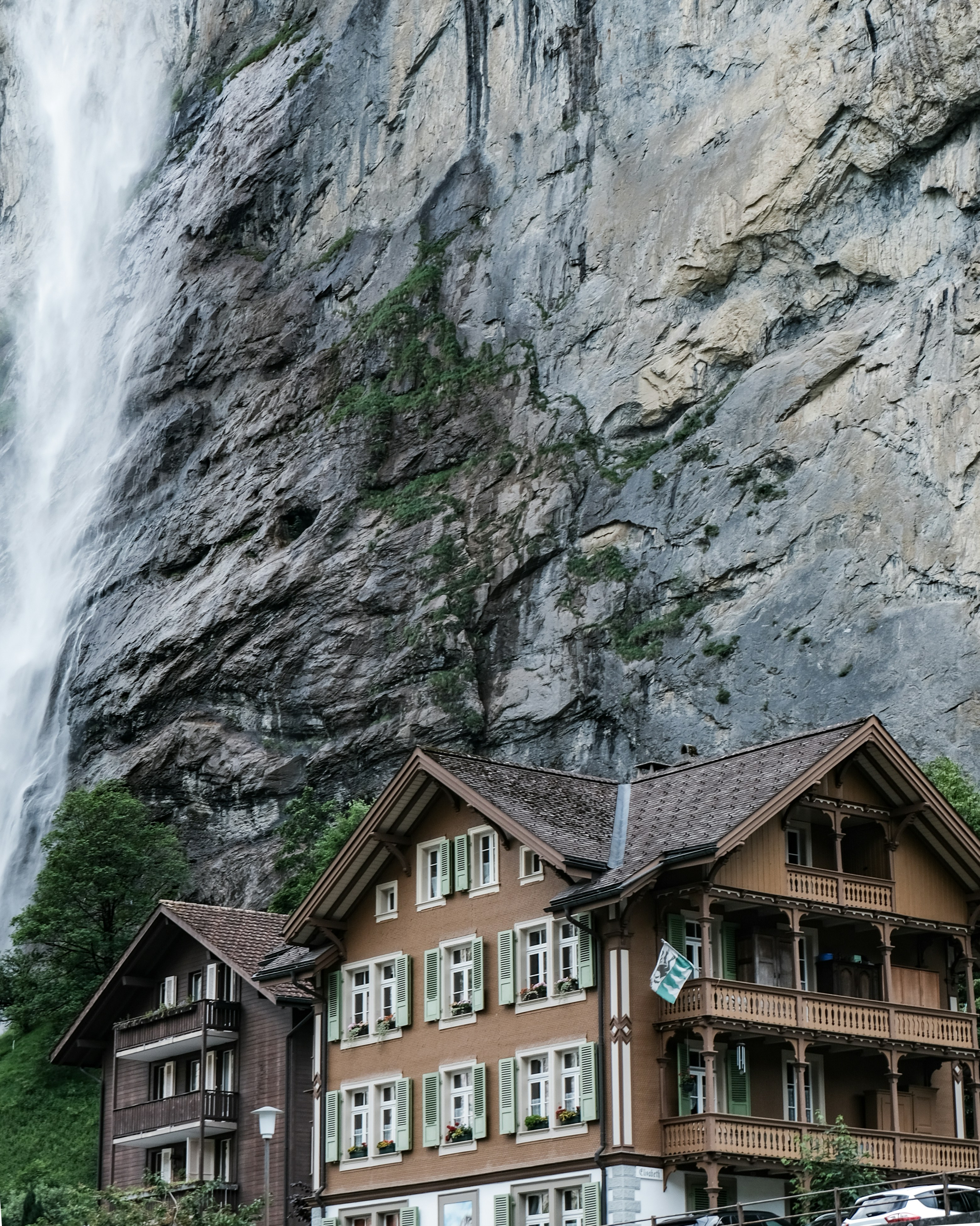 Chalet at the Base of a Thunderous Vertical Veil