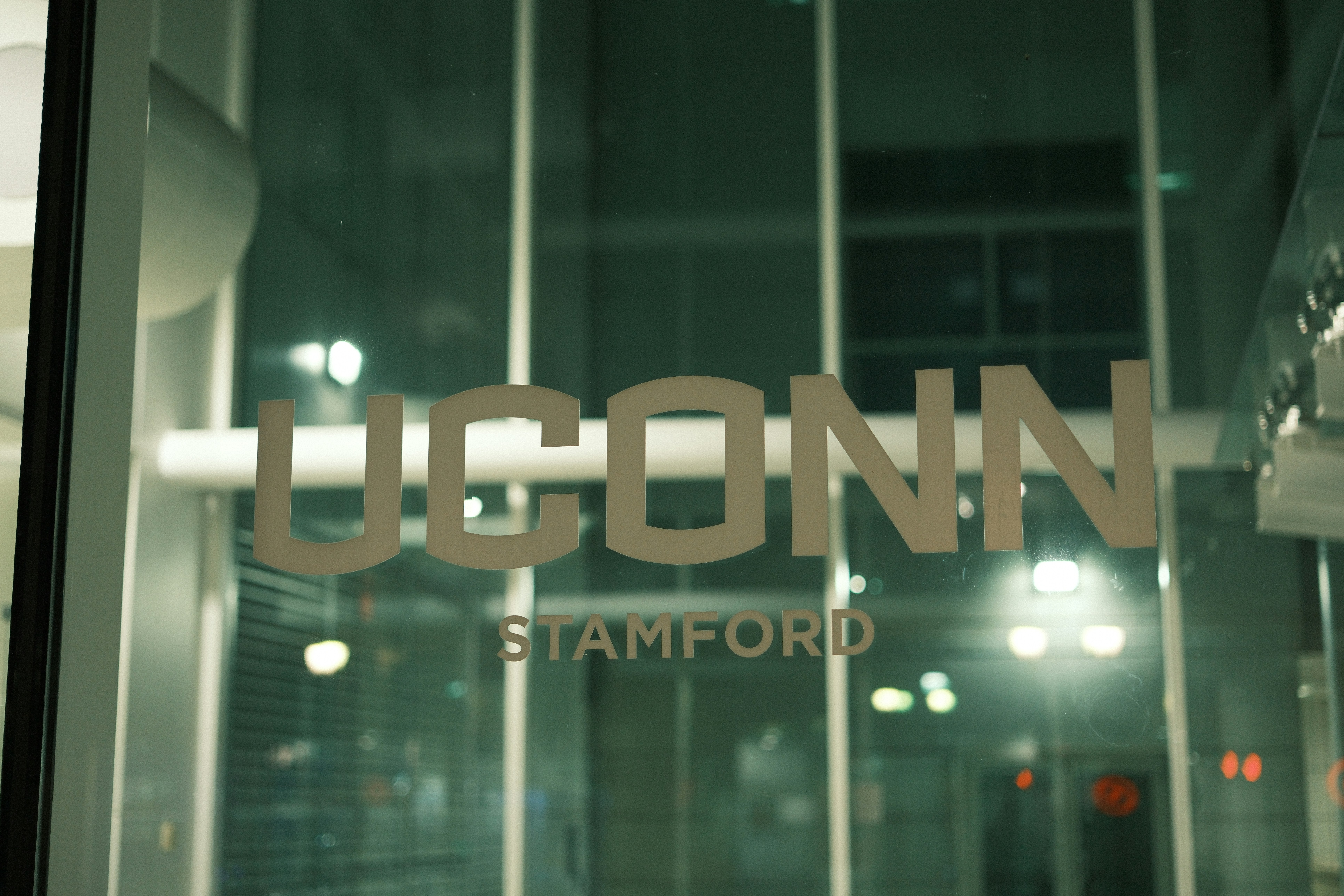 A glass door with the word uconn on it photo – Free Building Image on ...