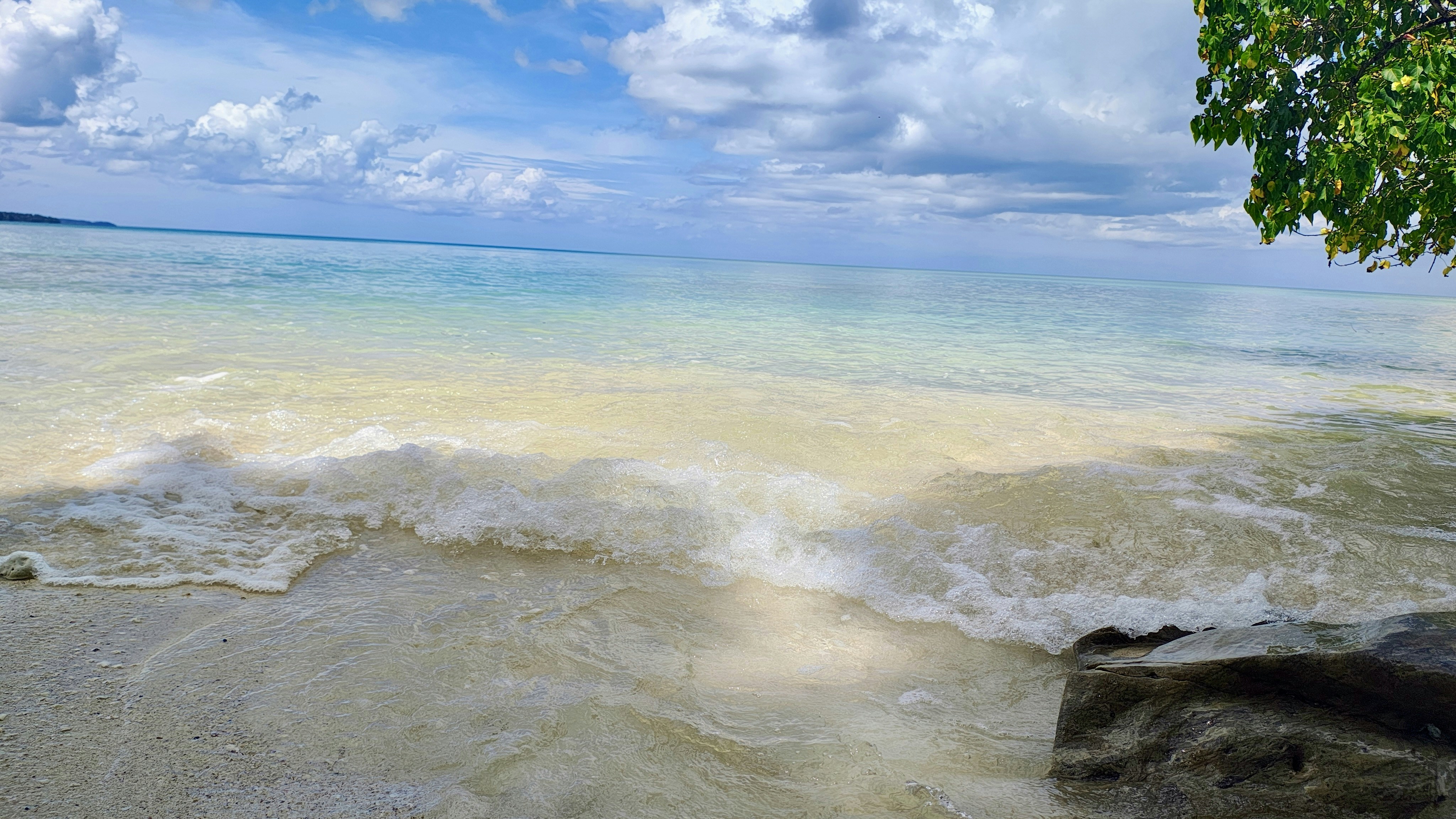 A view of the ocean from the shore of a beach photo – Free Wallpaper ...