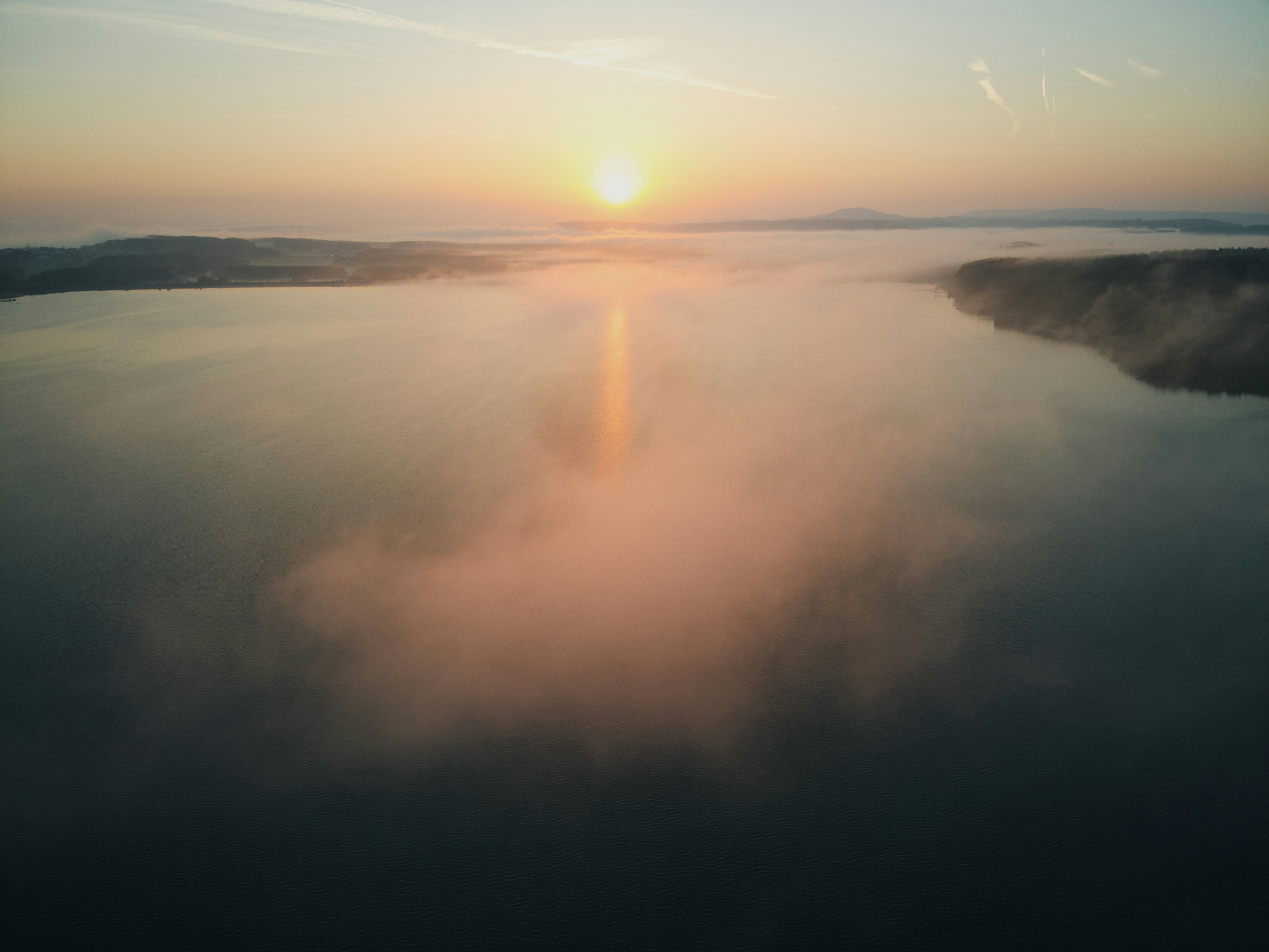 The sun is setting over a body of water