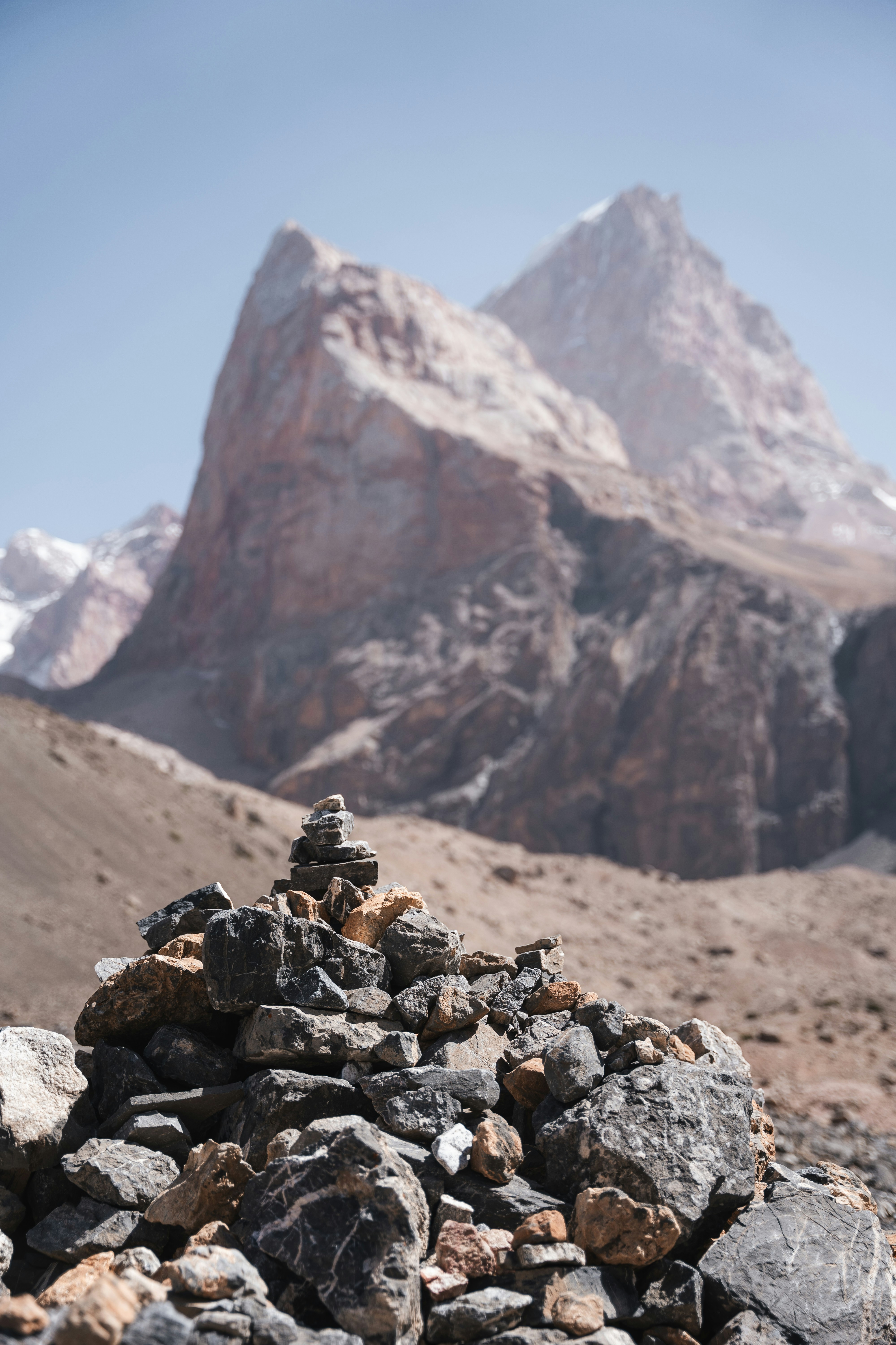 Cairn Sentinel at the Foot of Jagged Alpine Towers