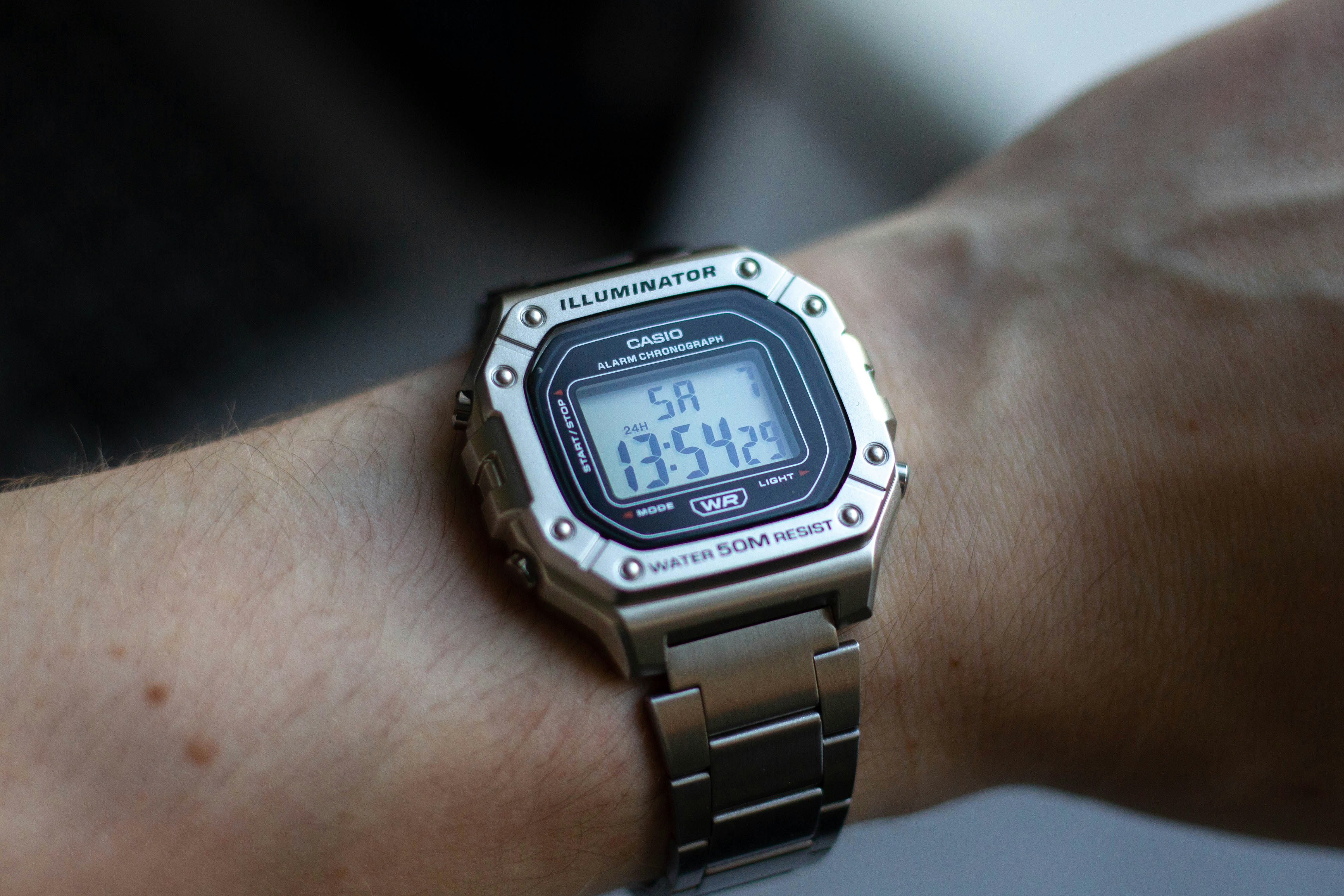 Illuminated Dial, Steely Precision: Close-Up of a Casio Digital Watch on a Wrist
