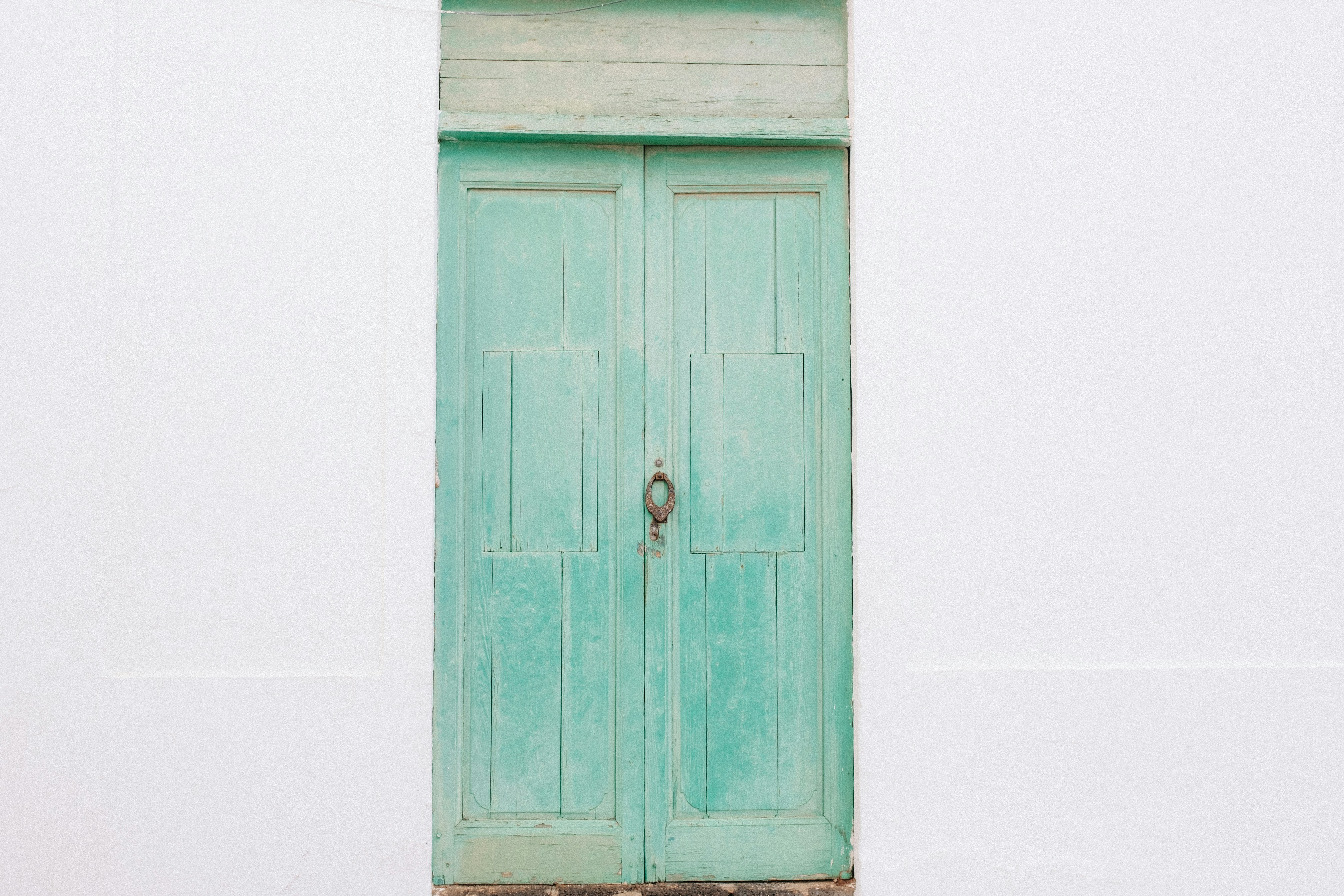 Mint Doorway on a Minimalist White Facade