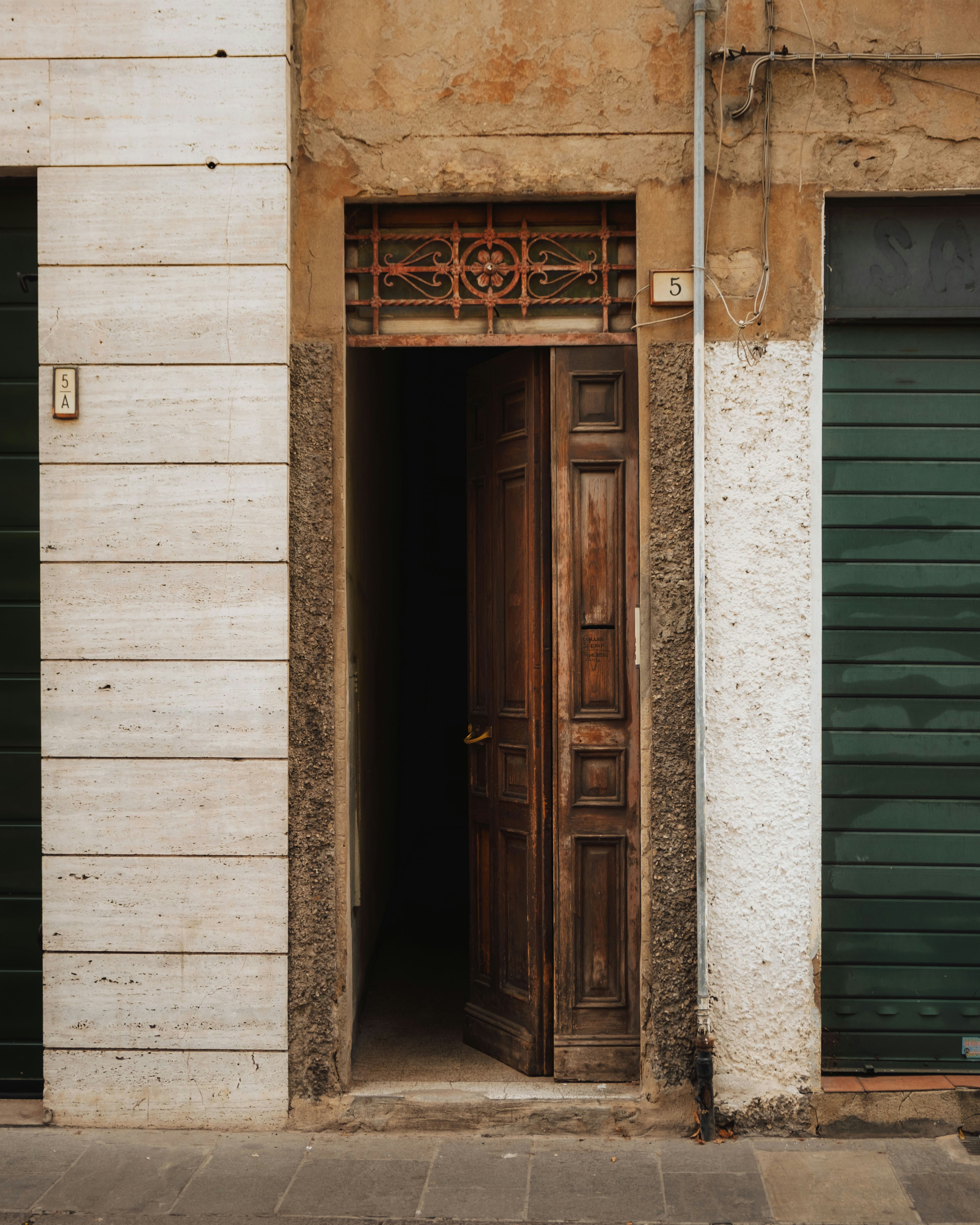 A couple of doors that are on the side of a building photo – Free ...