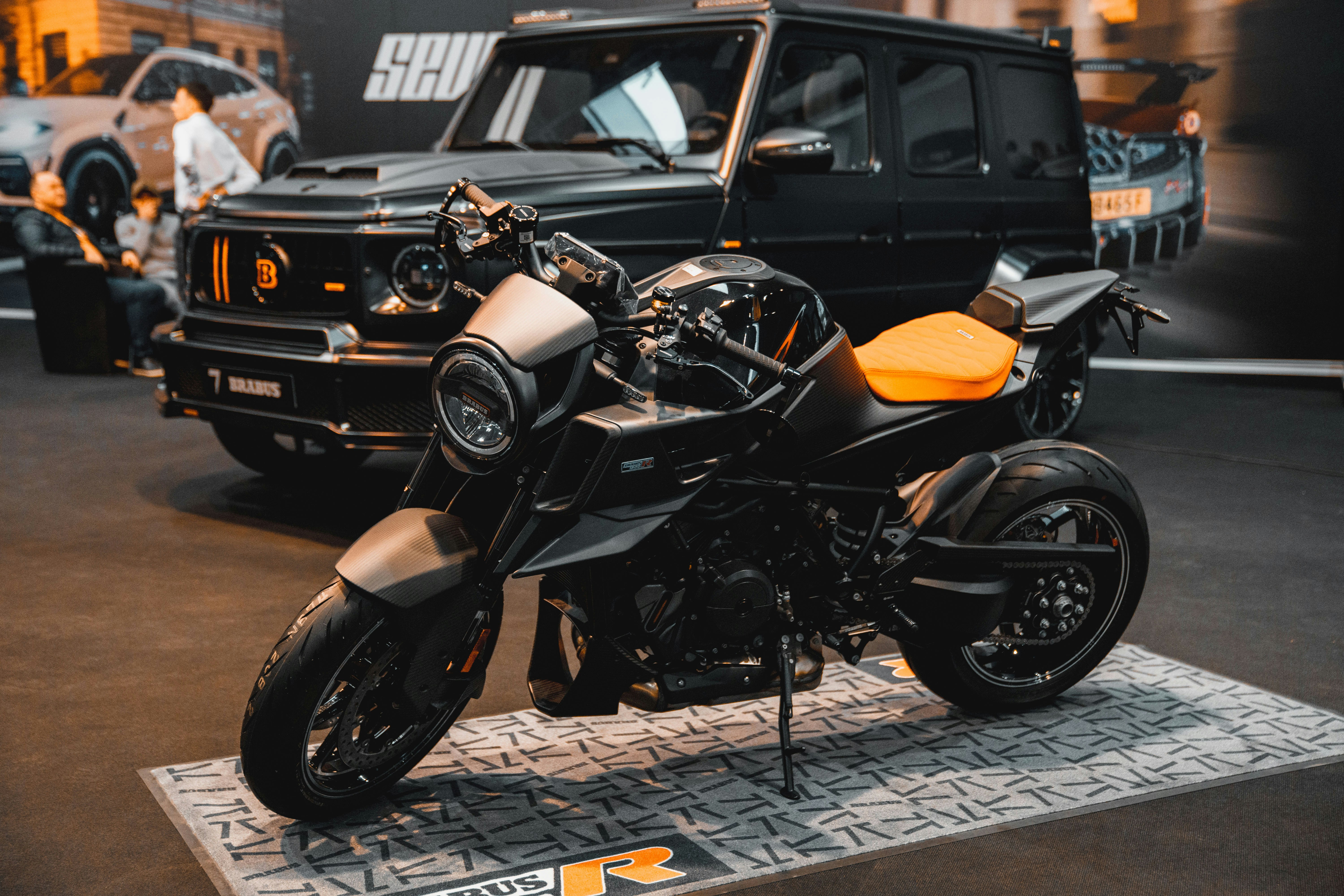 A motorcycle on display in front of a truck photo – Free Motorshow ...