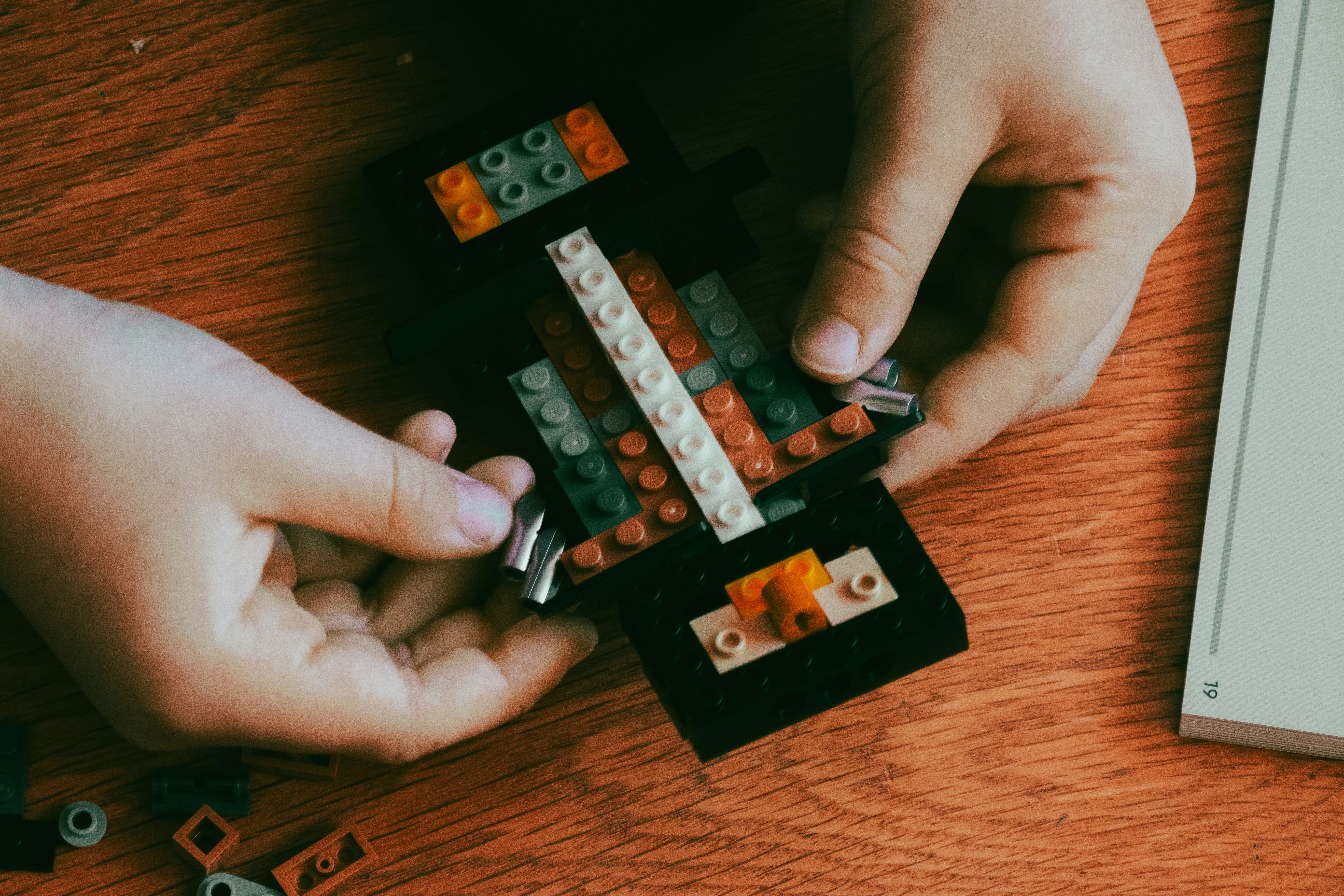 A person is playing with legos on a table photo – Free Human Image on ...
