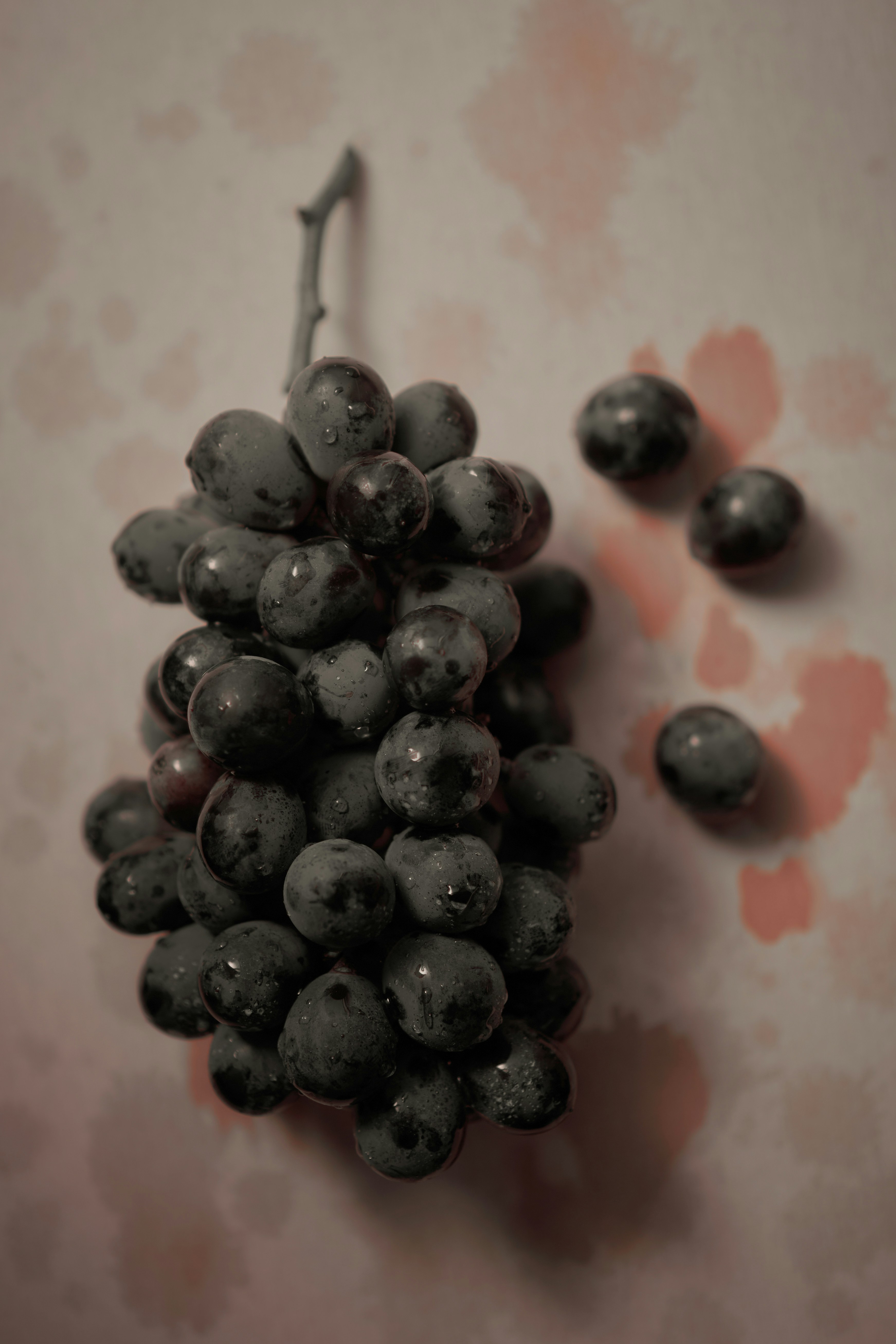 Nocturne of Grapes: a dew-kissed cluster on a pink-hued backdrop