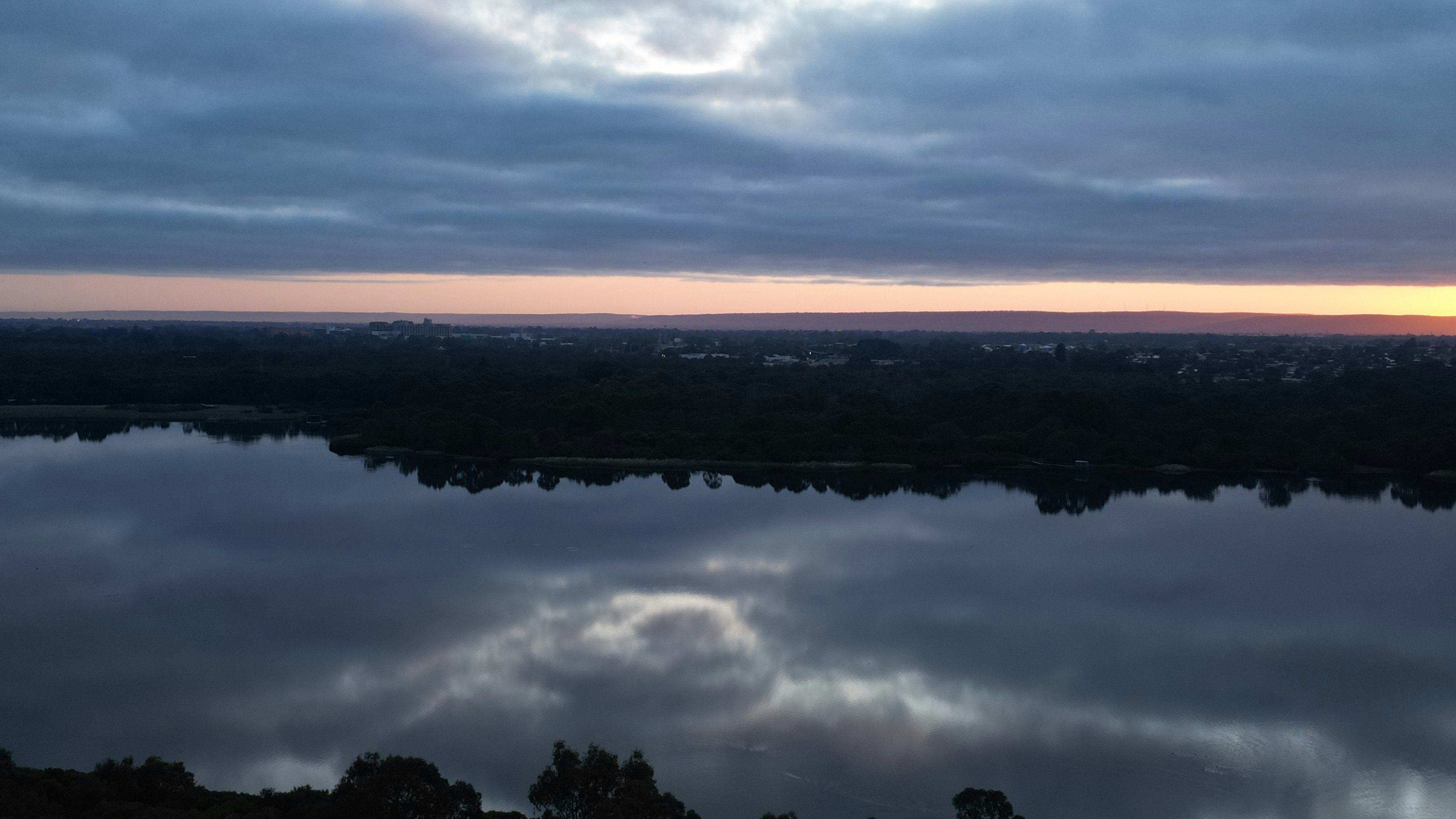 Horizon Glass: Sunset Reflections Over a Quiet Waterway