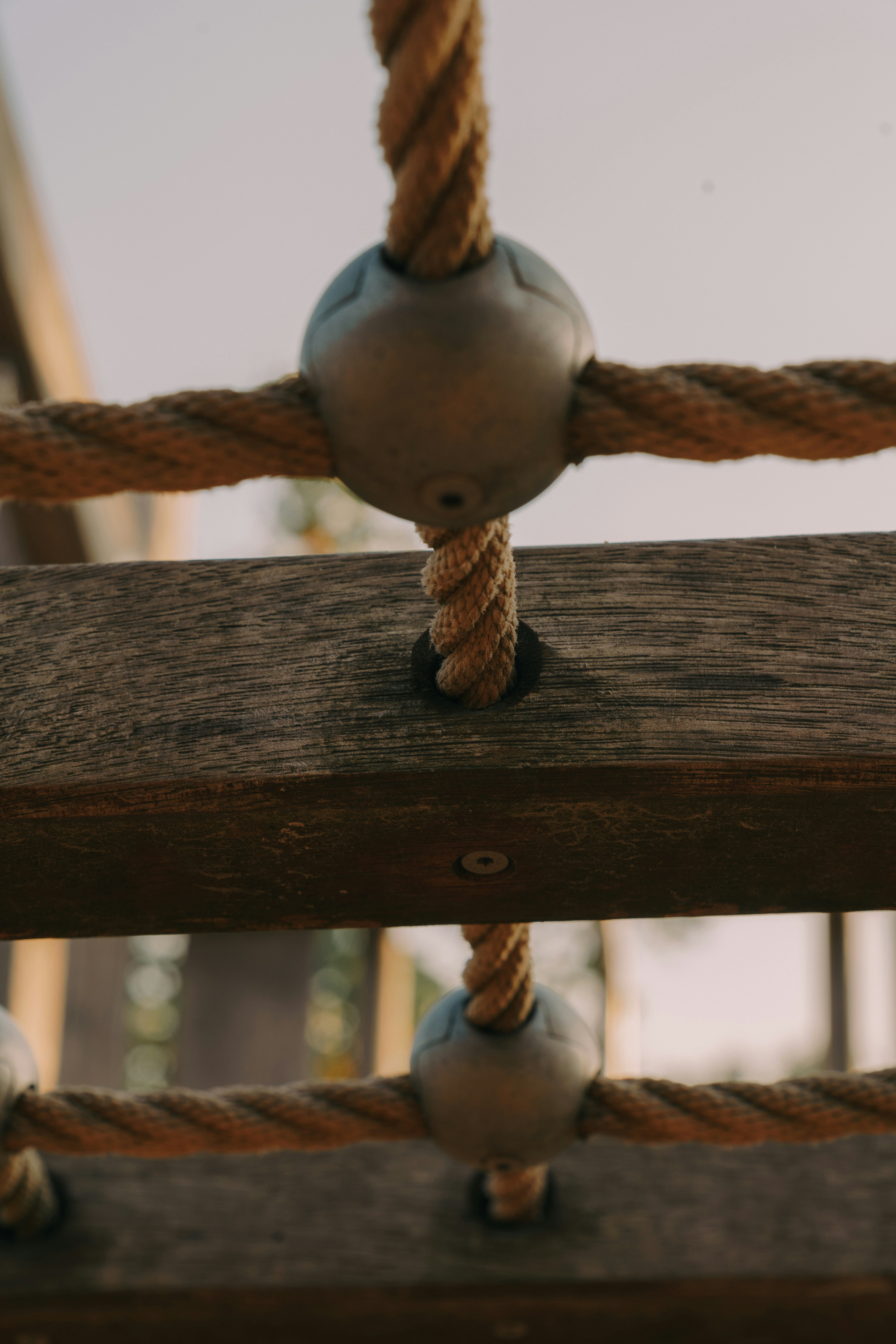 Crossing Ropes: A Close-Up of Weathered Wood and Tension