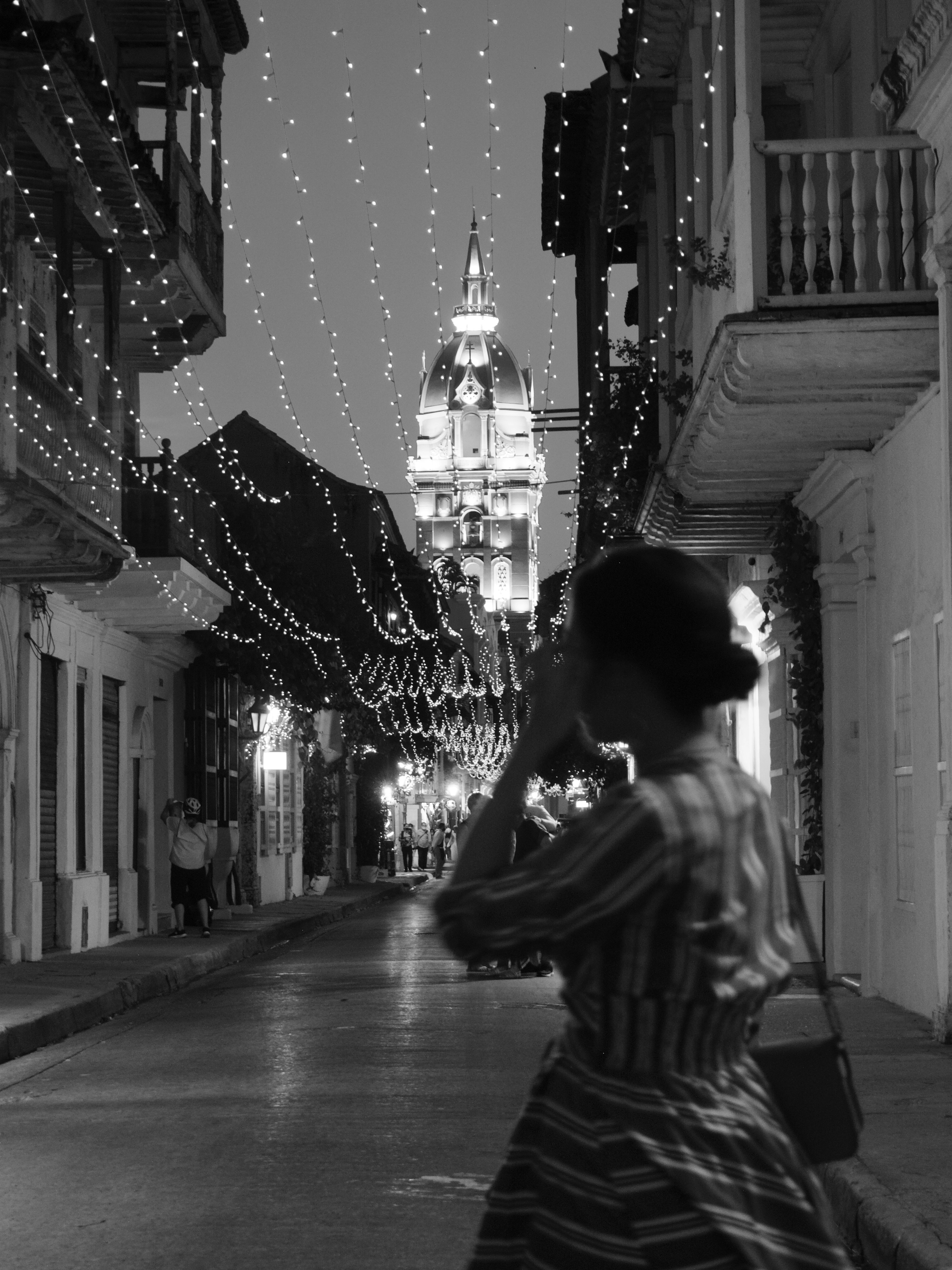 Night Street in Bloom: A Portrait Beneath the Illuminate Arc