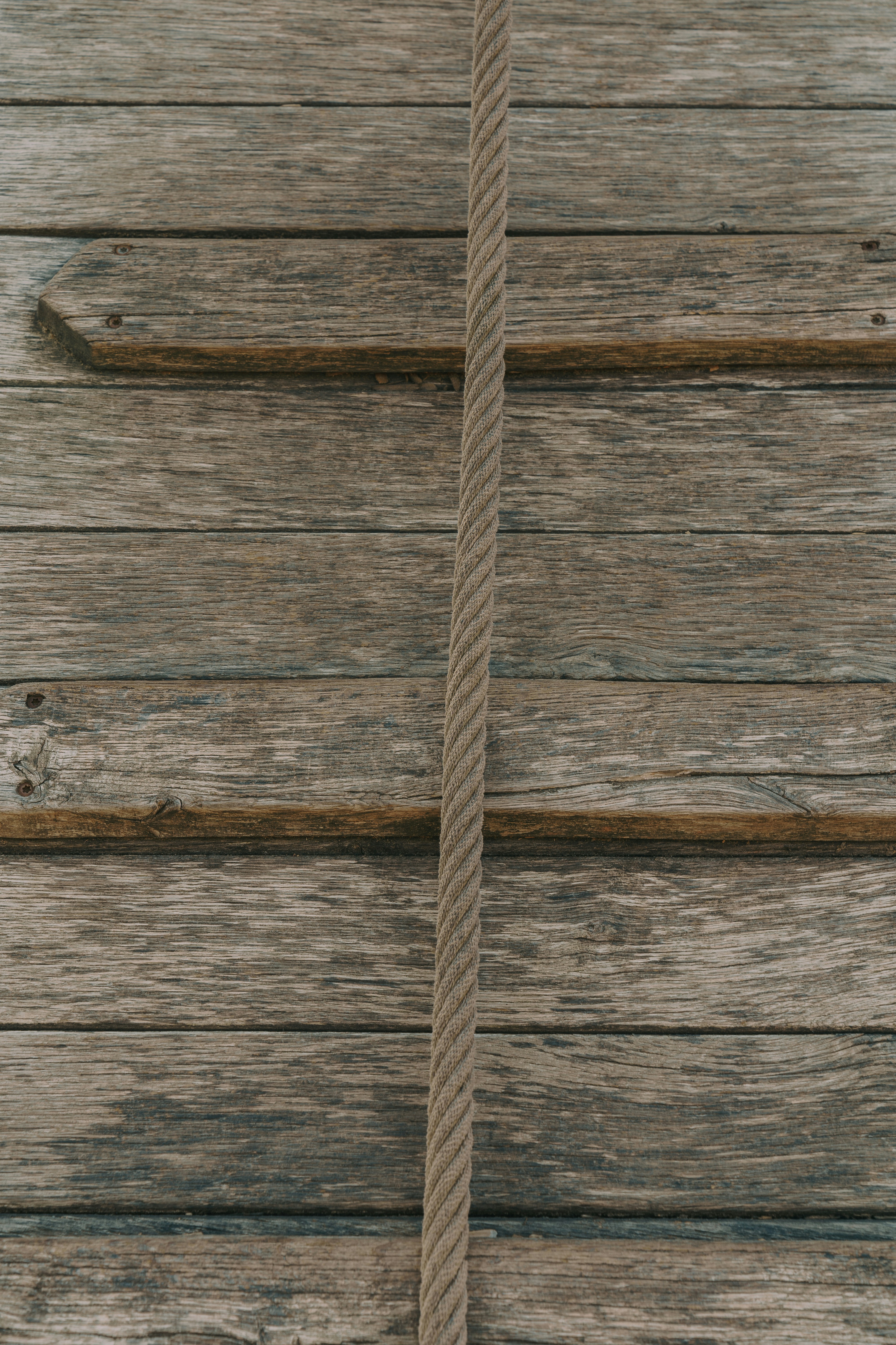 Centerline of Weathered Timber: A Rope Dividing the Deck