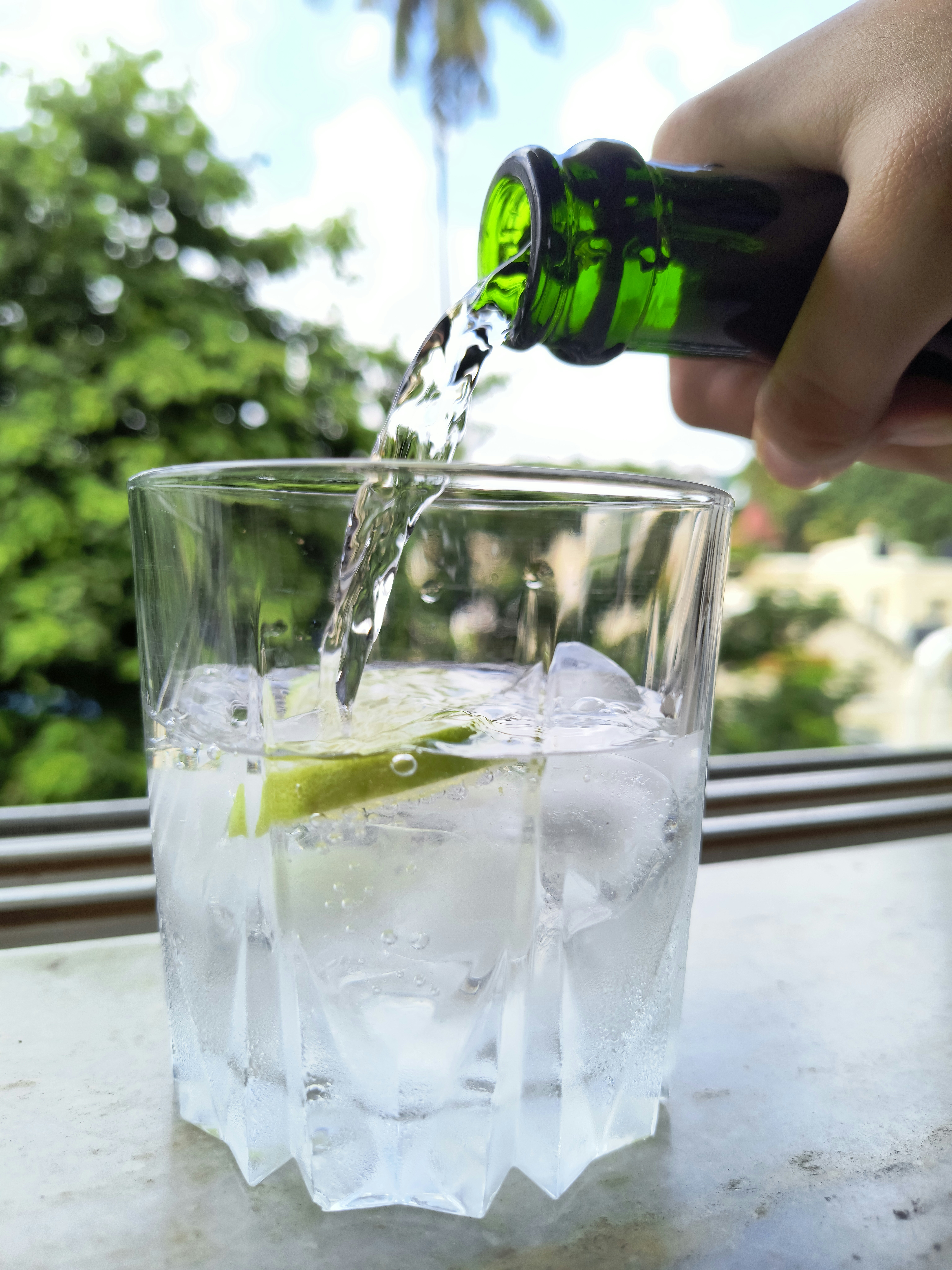 A person is pouring water into a glass