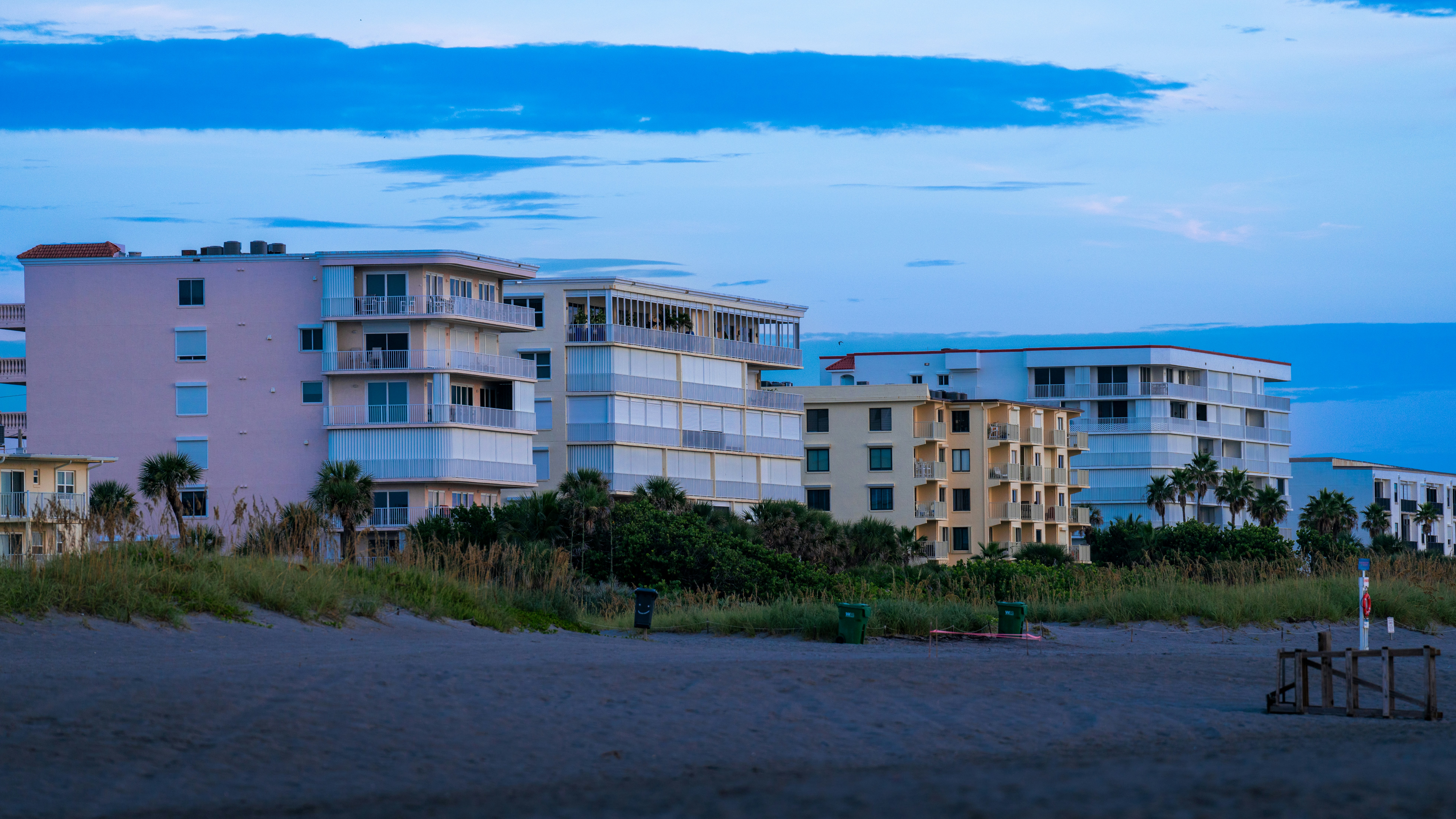 A row of multi - story buildings on a beach photo – Free Sunrise beach ...