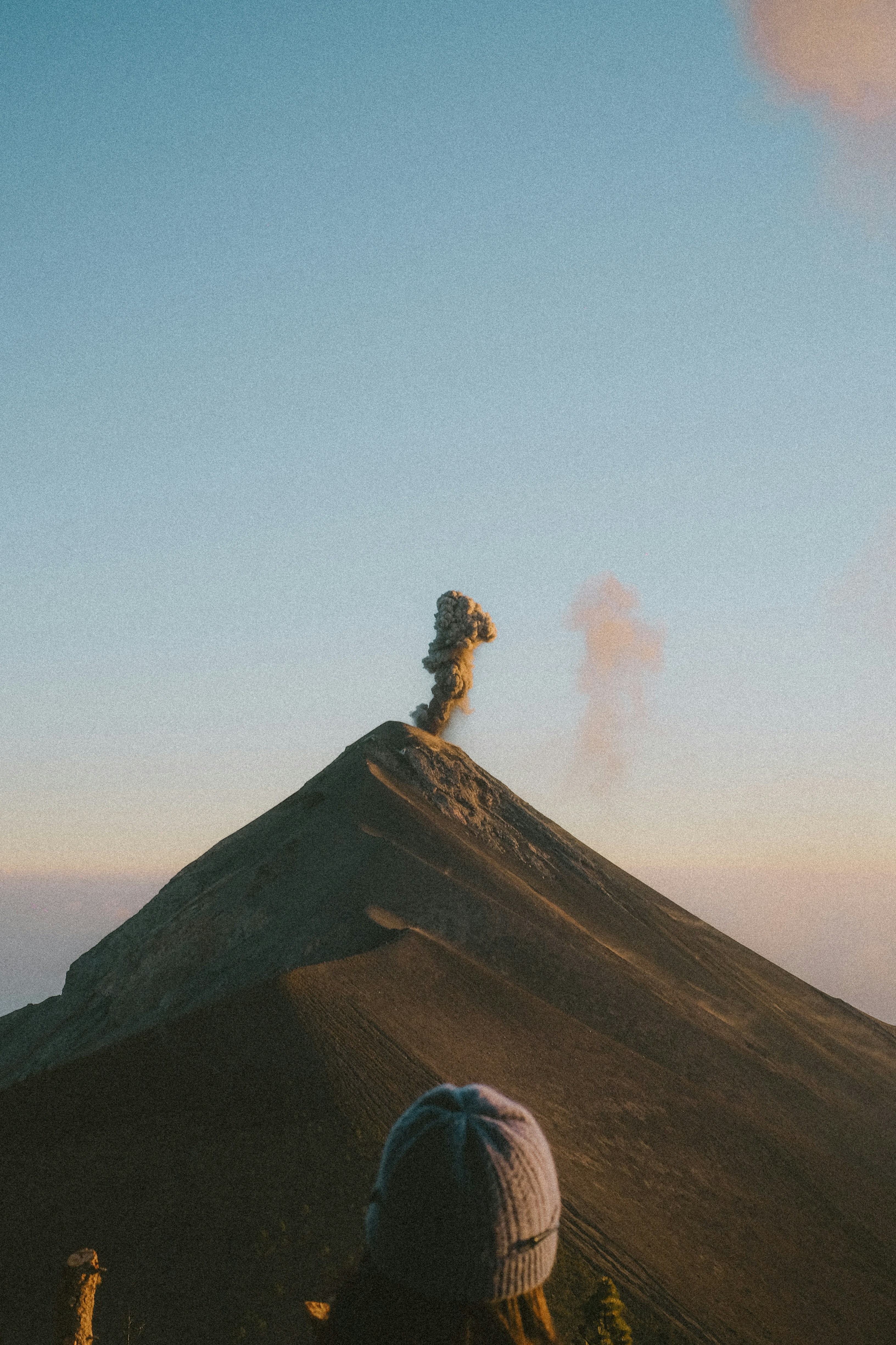 an exploding vulcano in guatemala | A person standing on top of a mountain