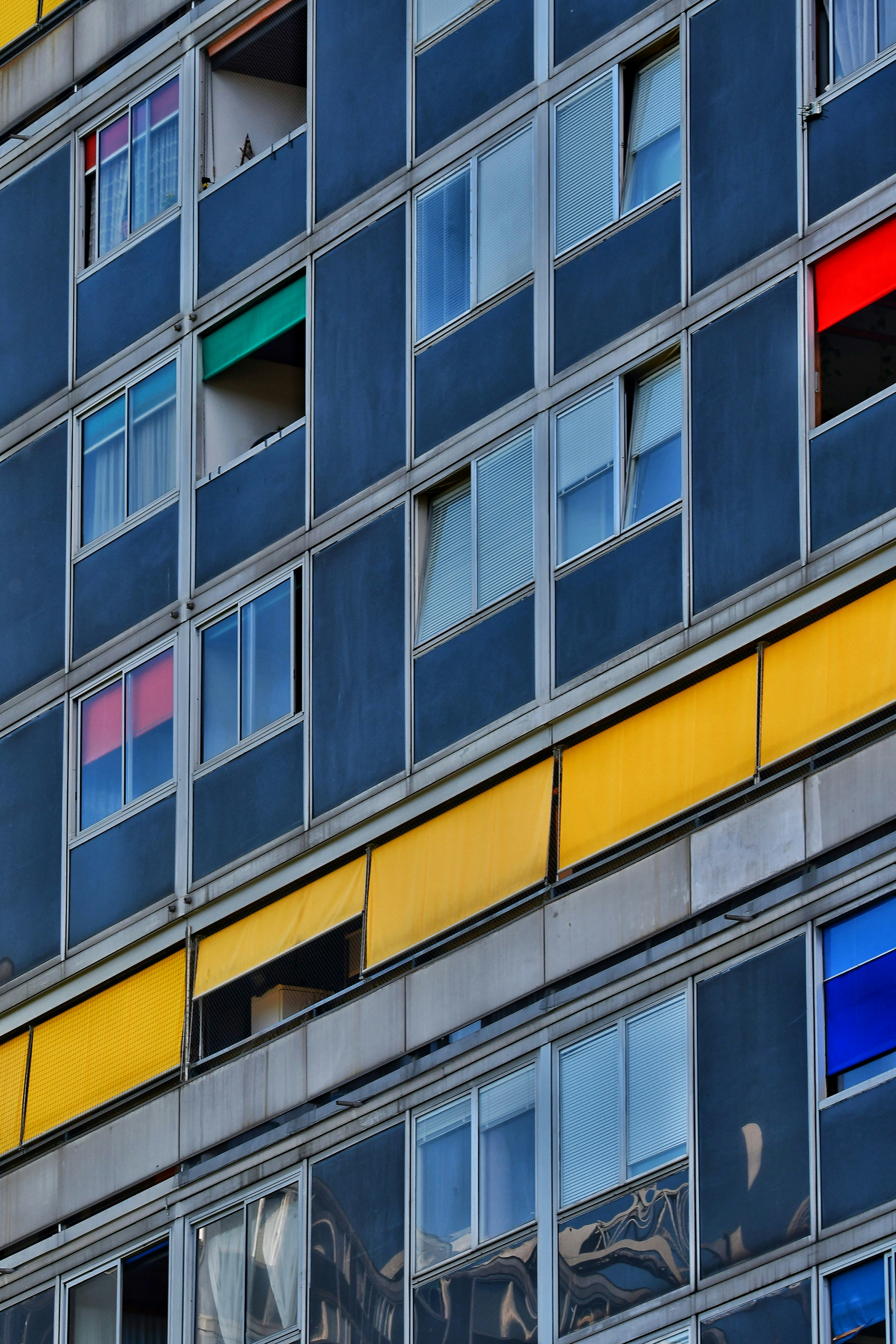 A multicolored building with a clock on the side of it photo – Free Le ...