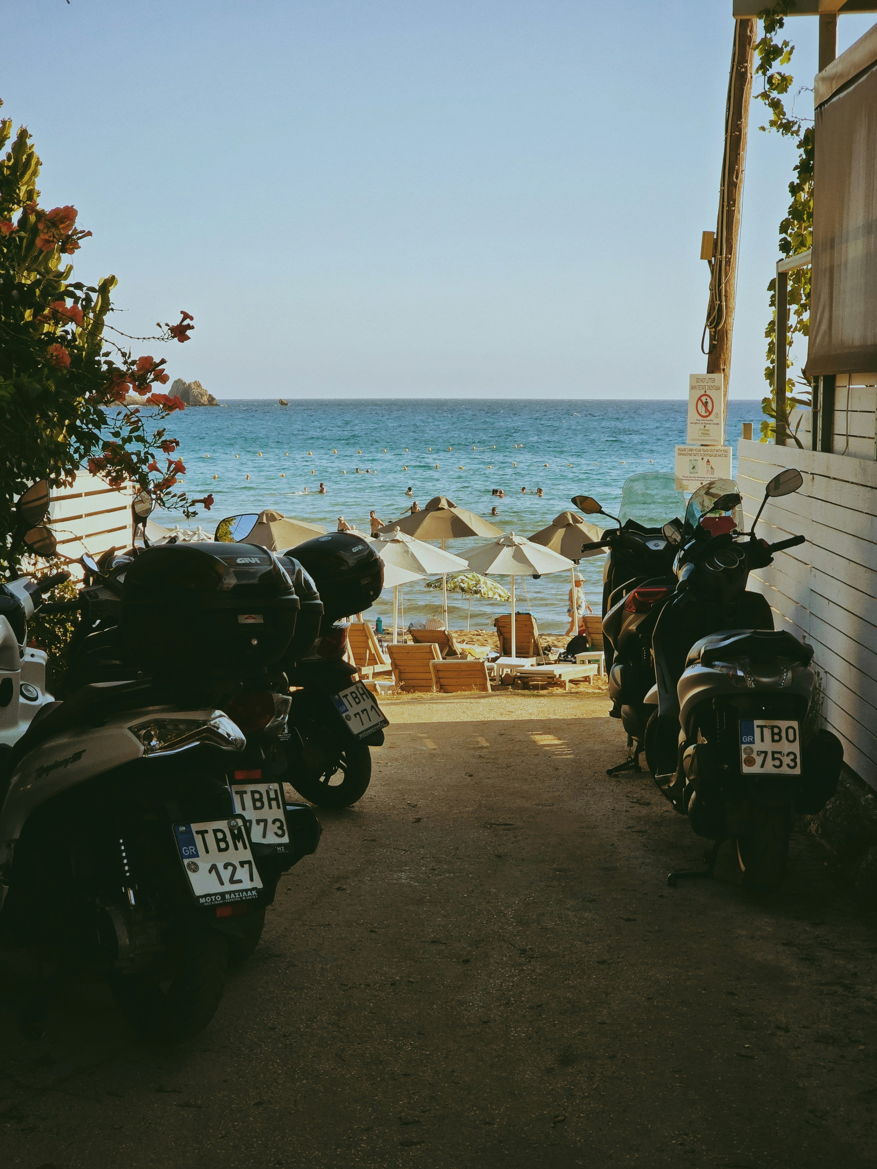 Beach Entrance: Motorbikes Framing a Sea-View Corridor