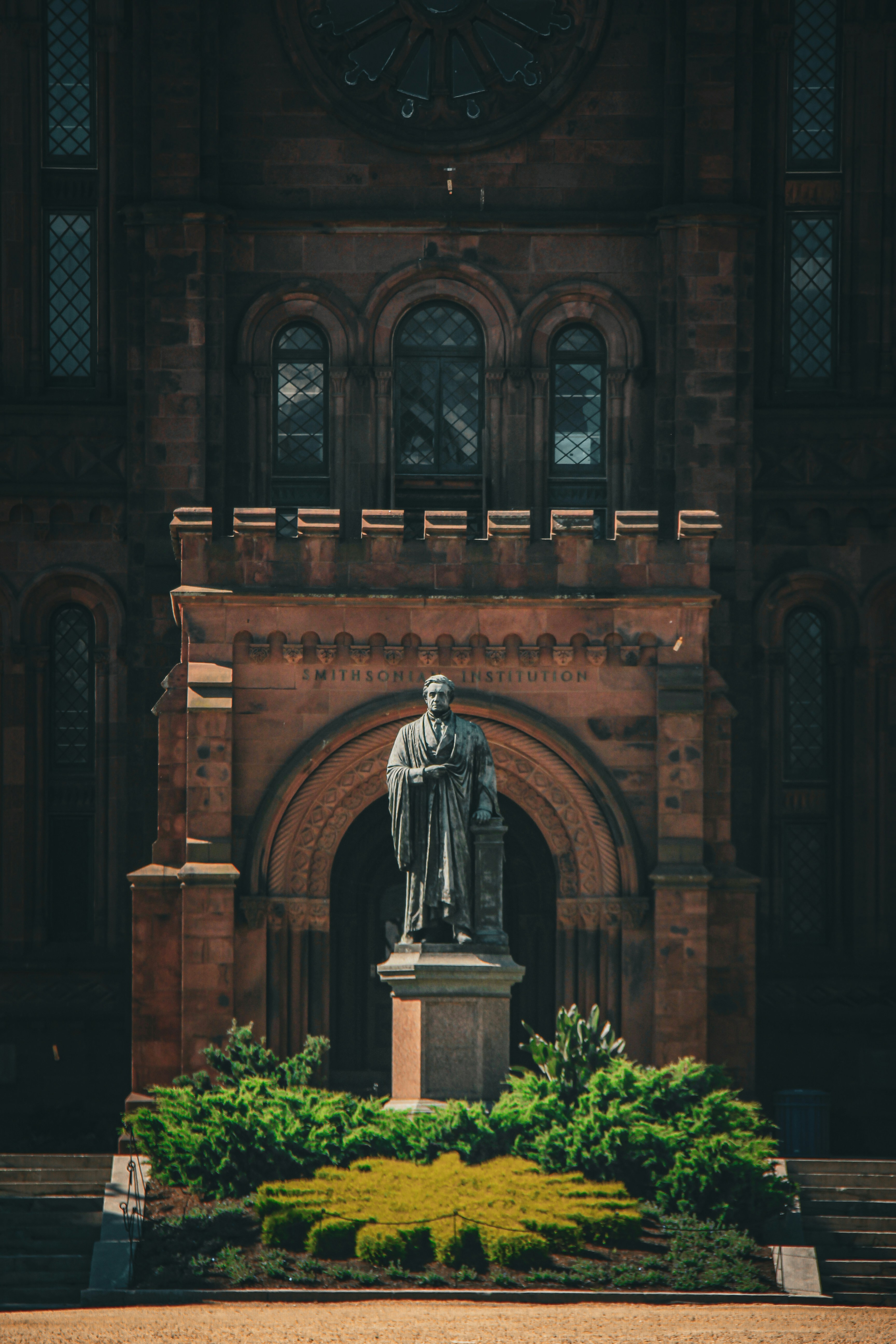 Statue Crowned by an Archway: A Quiet Courtyard Portrait
