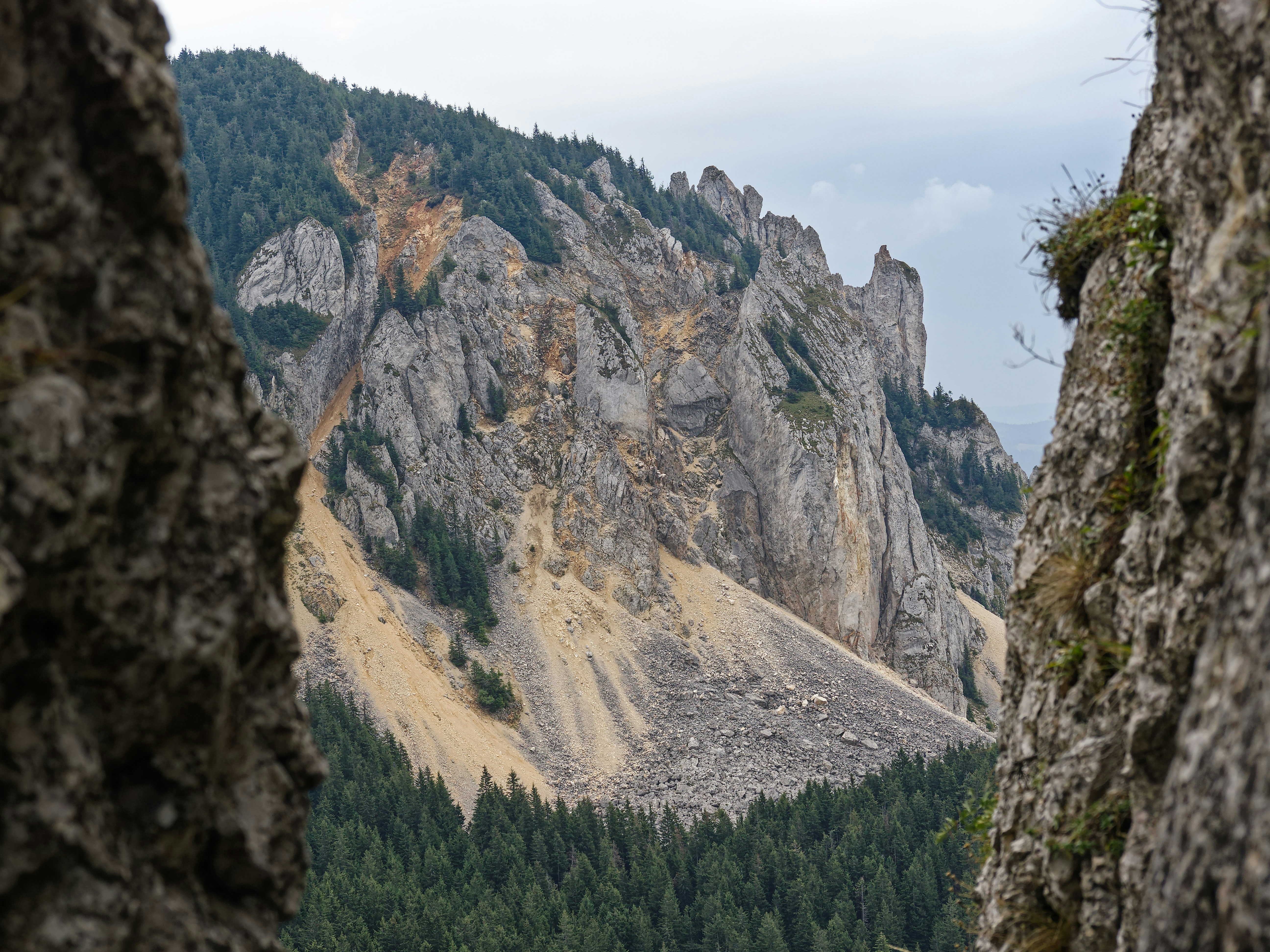 A view of a mountain from between two rocks photo – Free Cliff Image on ...