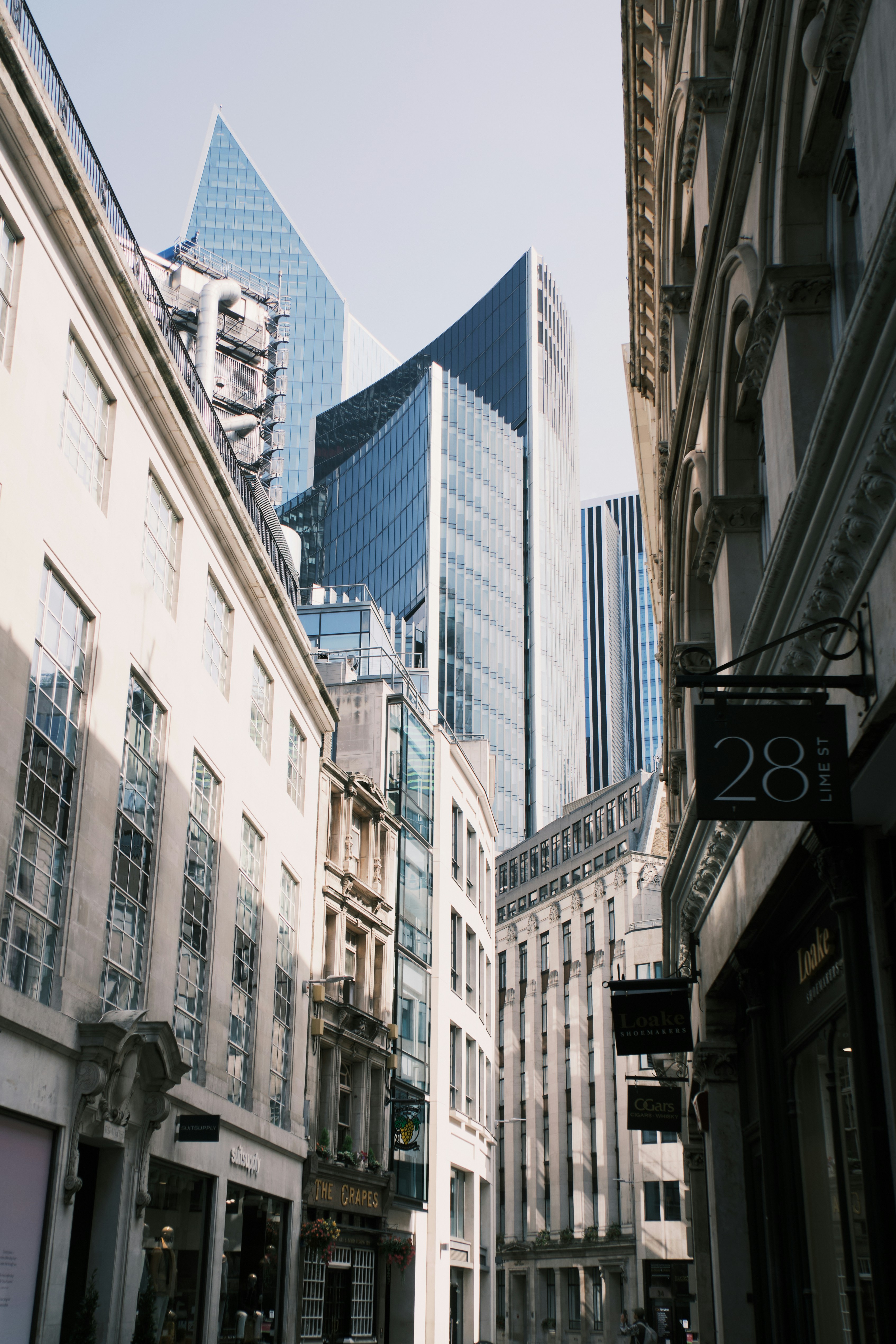 A narrow city street with tall buildings in the background photo – Free ...