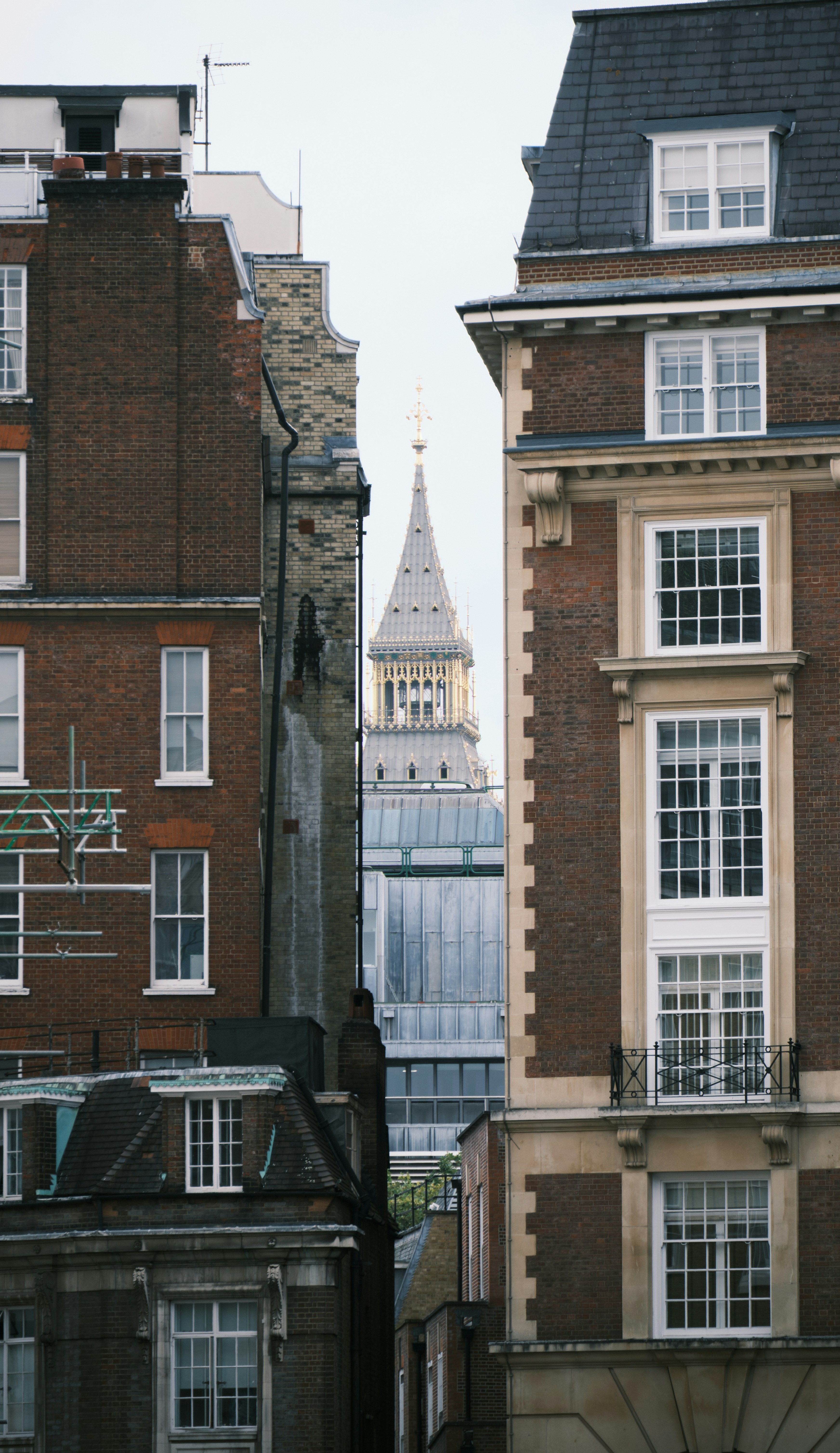 A view of some buildings and a clock tower in the distance photo – Free ...