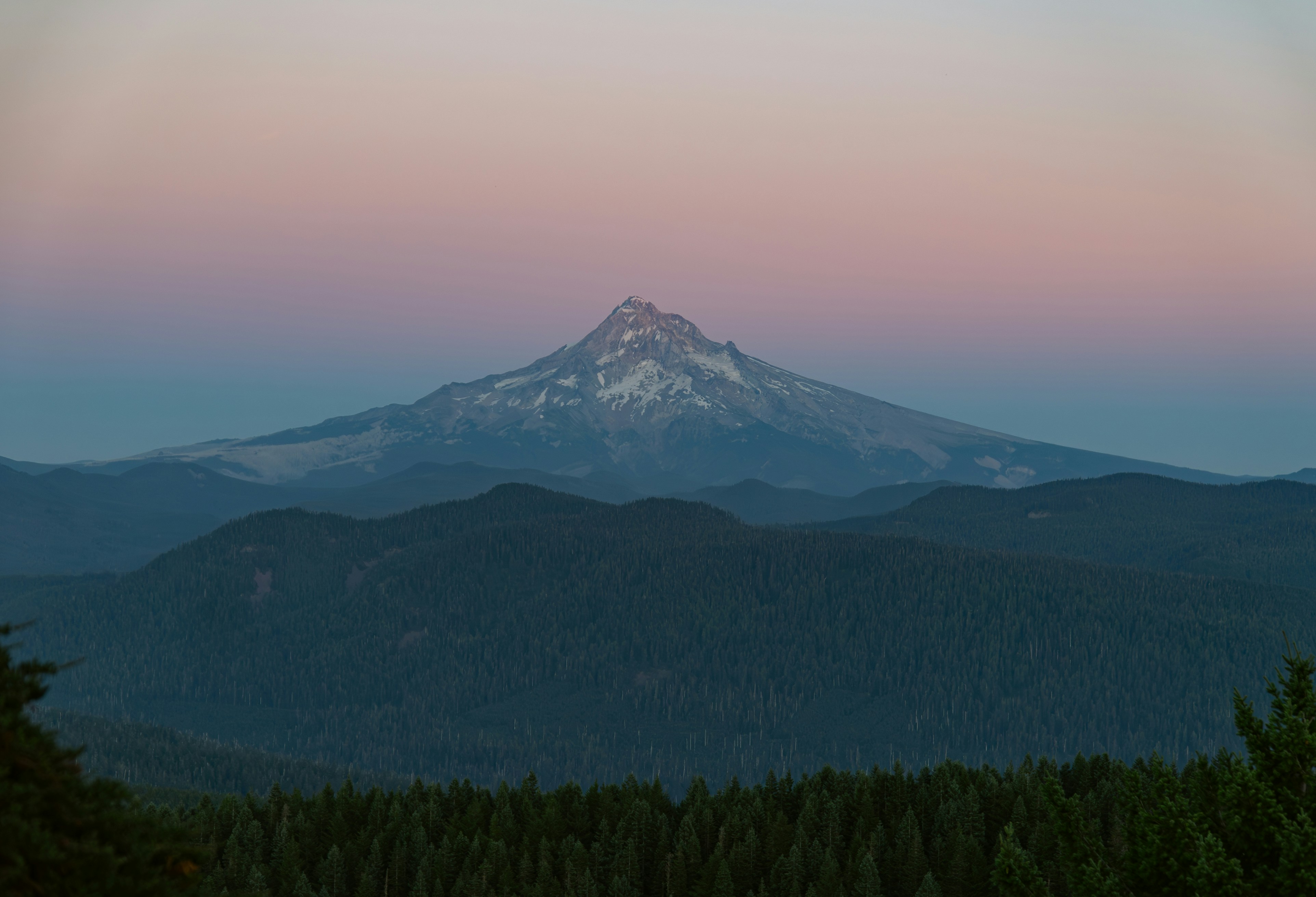 Dawn's Quiet Summit: Snow-Crowned Peak Above Velvet Forest