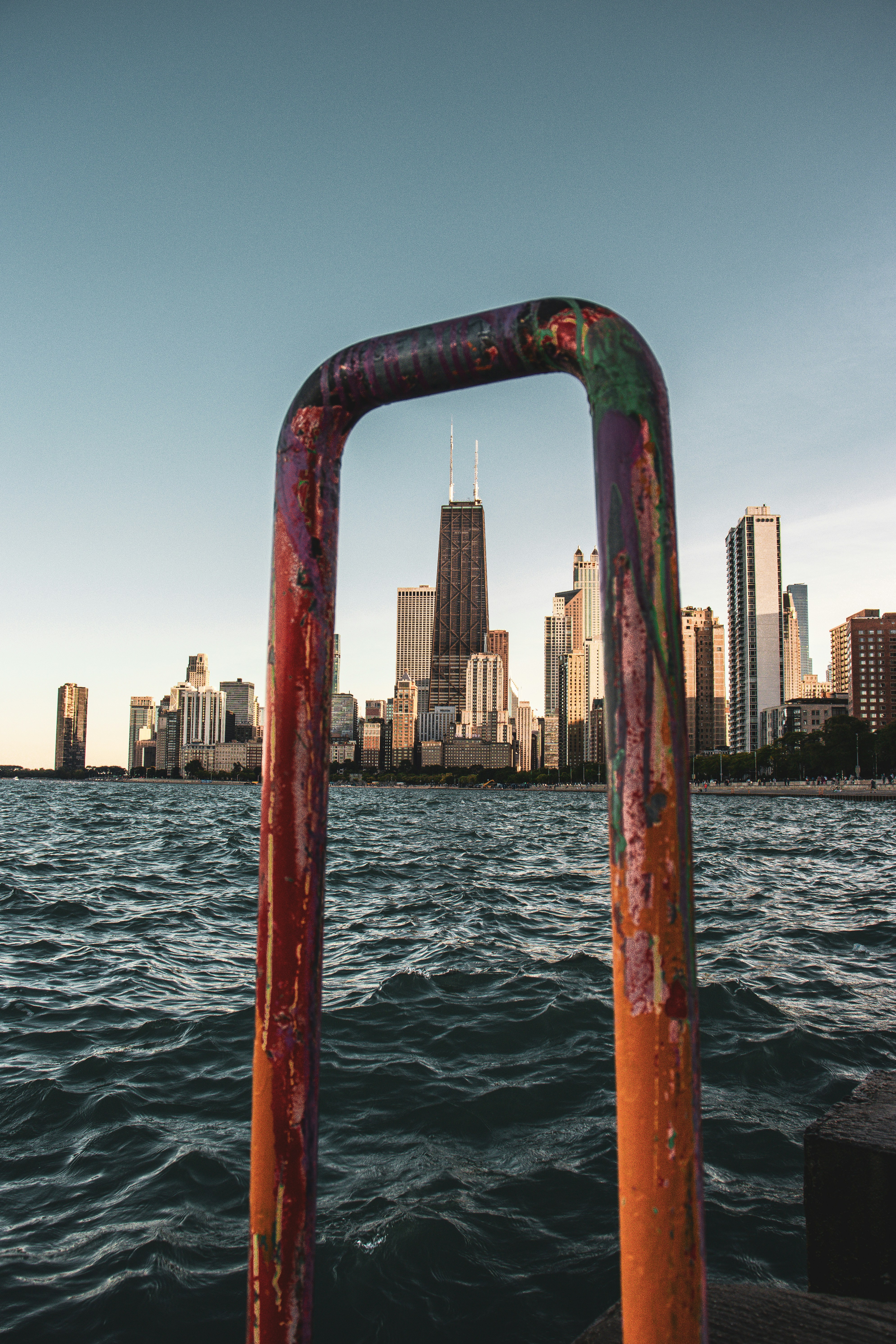 Colorful Arch Framing the Skyline Over Calm Waters