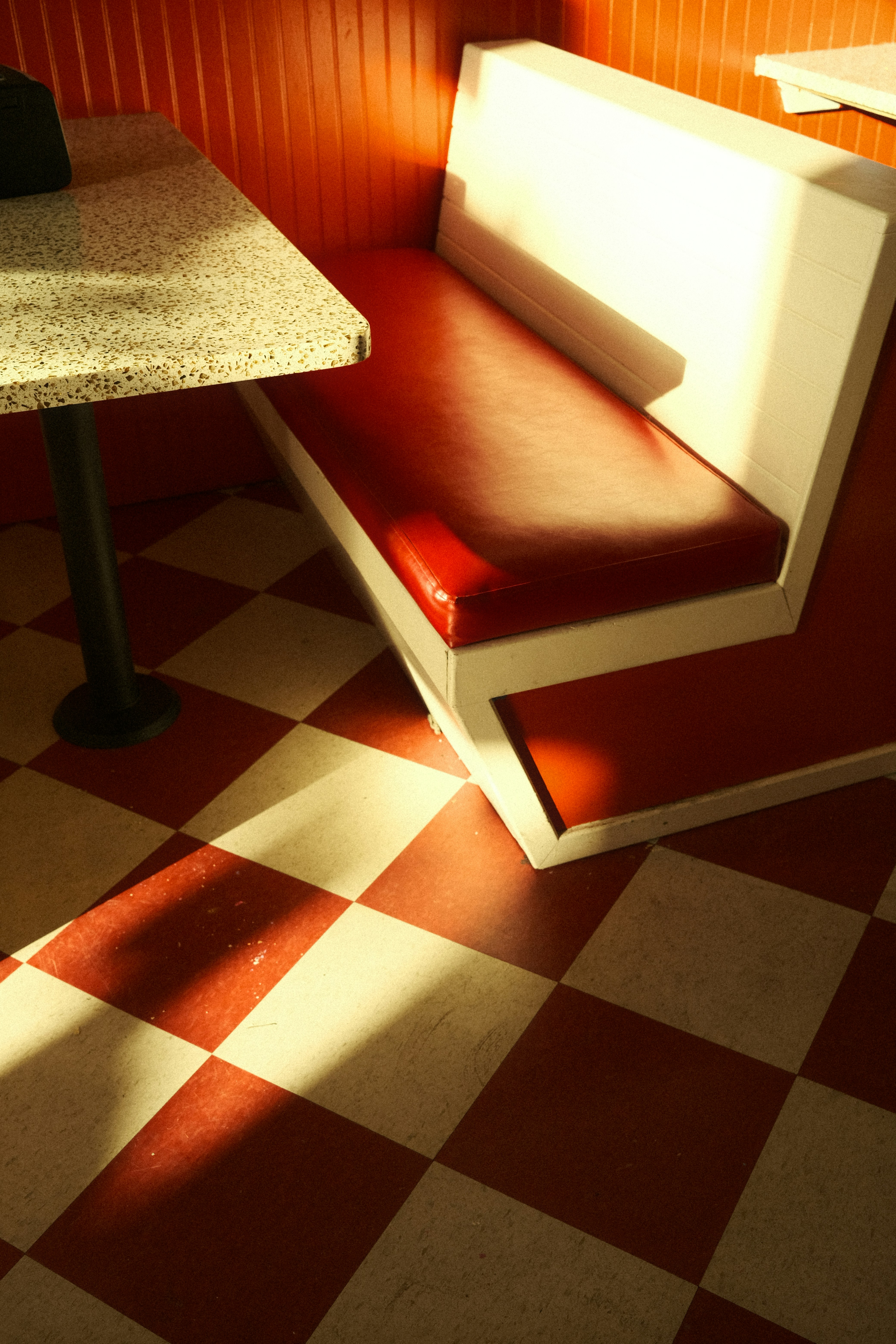 Sunlit Red Booth in a Quiet Retro Diner