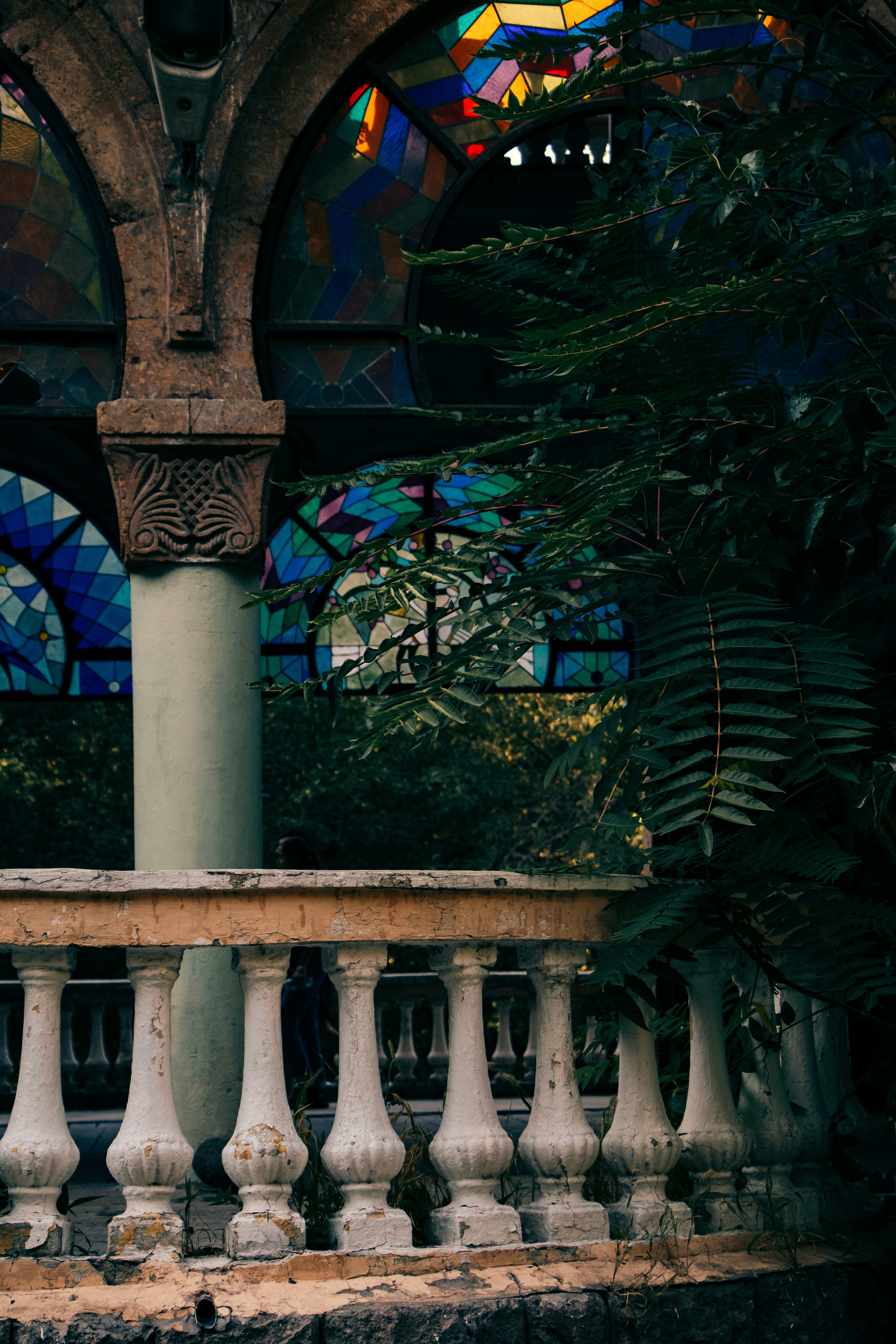 A building with stained glass windows and a balcony photo – Free ...