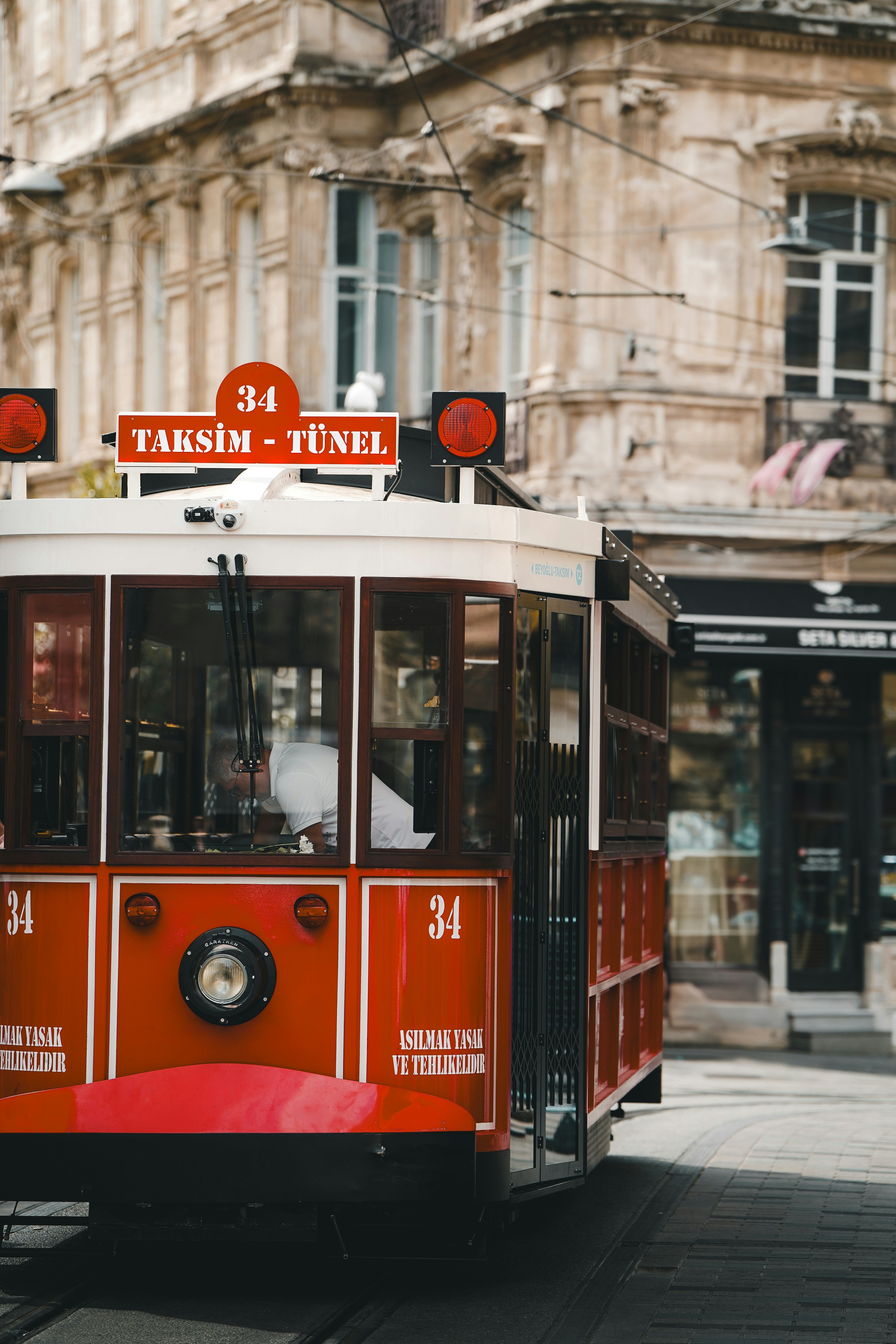 A red and white trolley car traveling down a street photo – Free ...
