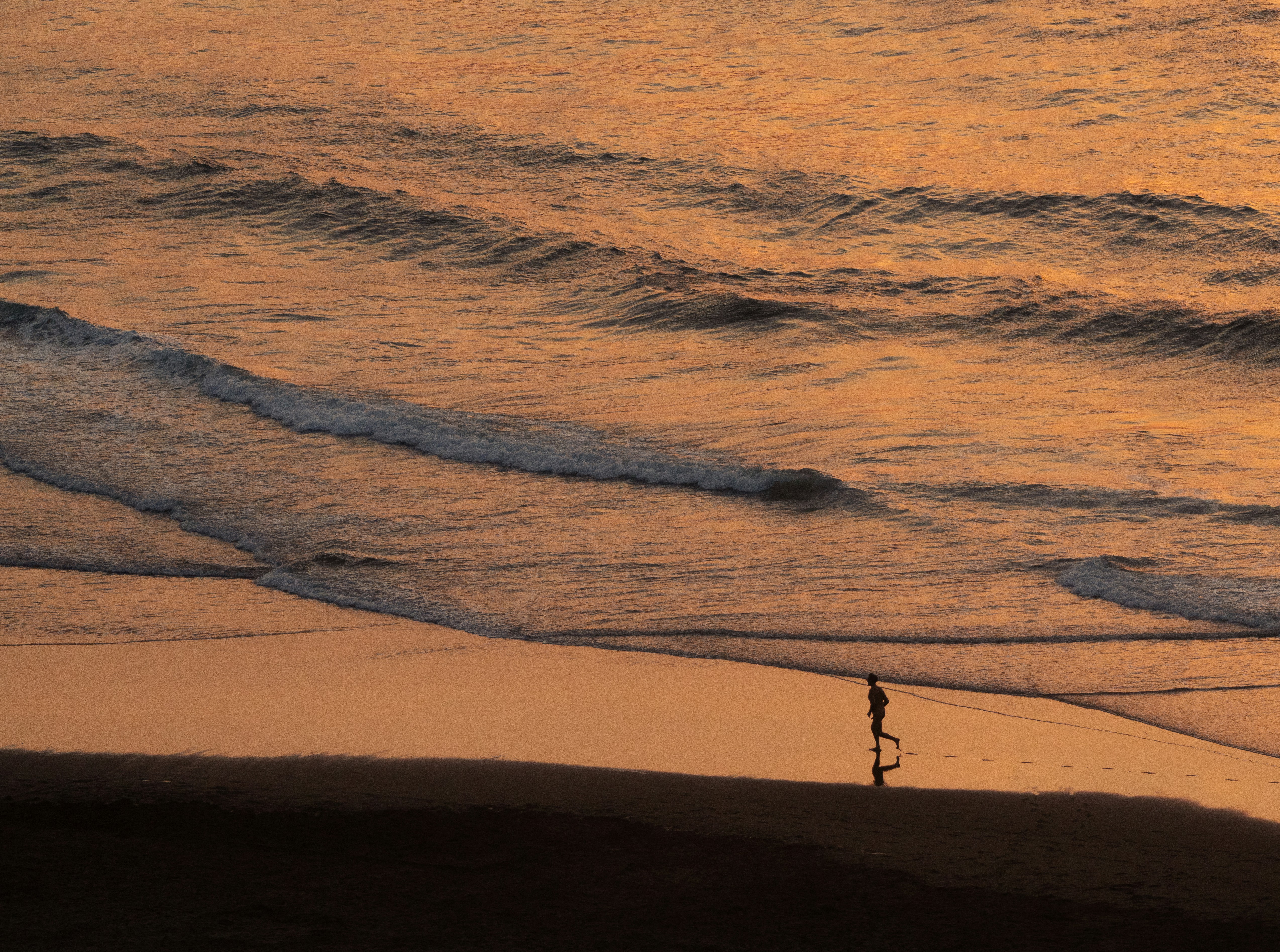 Guy walking at sunset.
