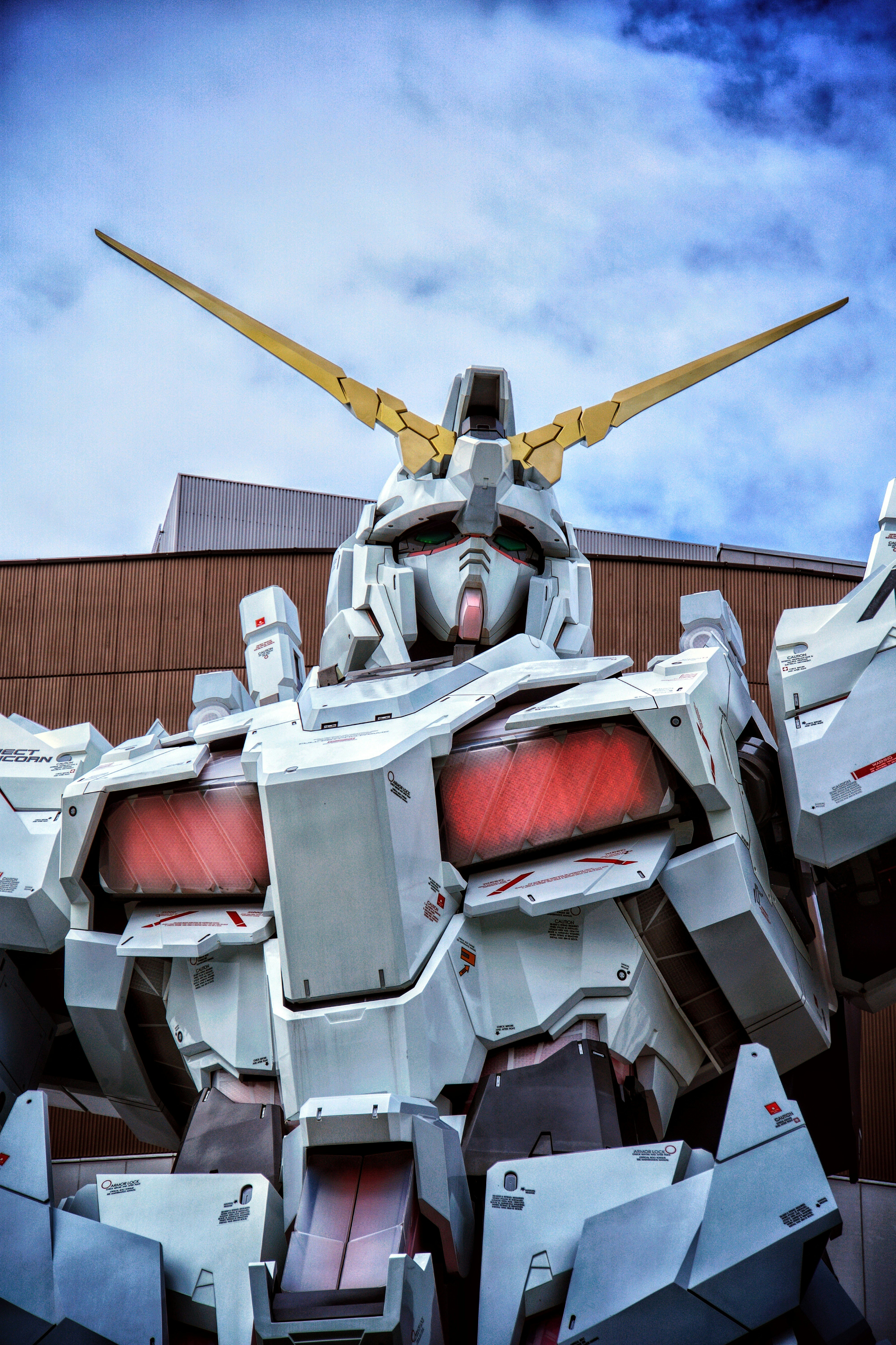 Gigantic Gundam Sentinel: Titanium Frame Against a Sky-Wlecked Roof