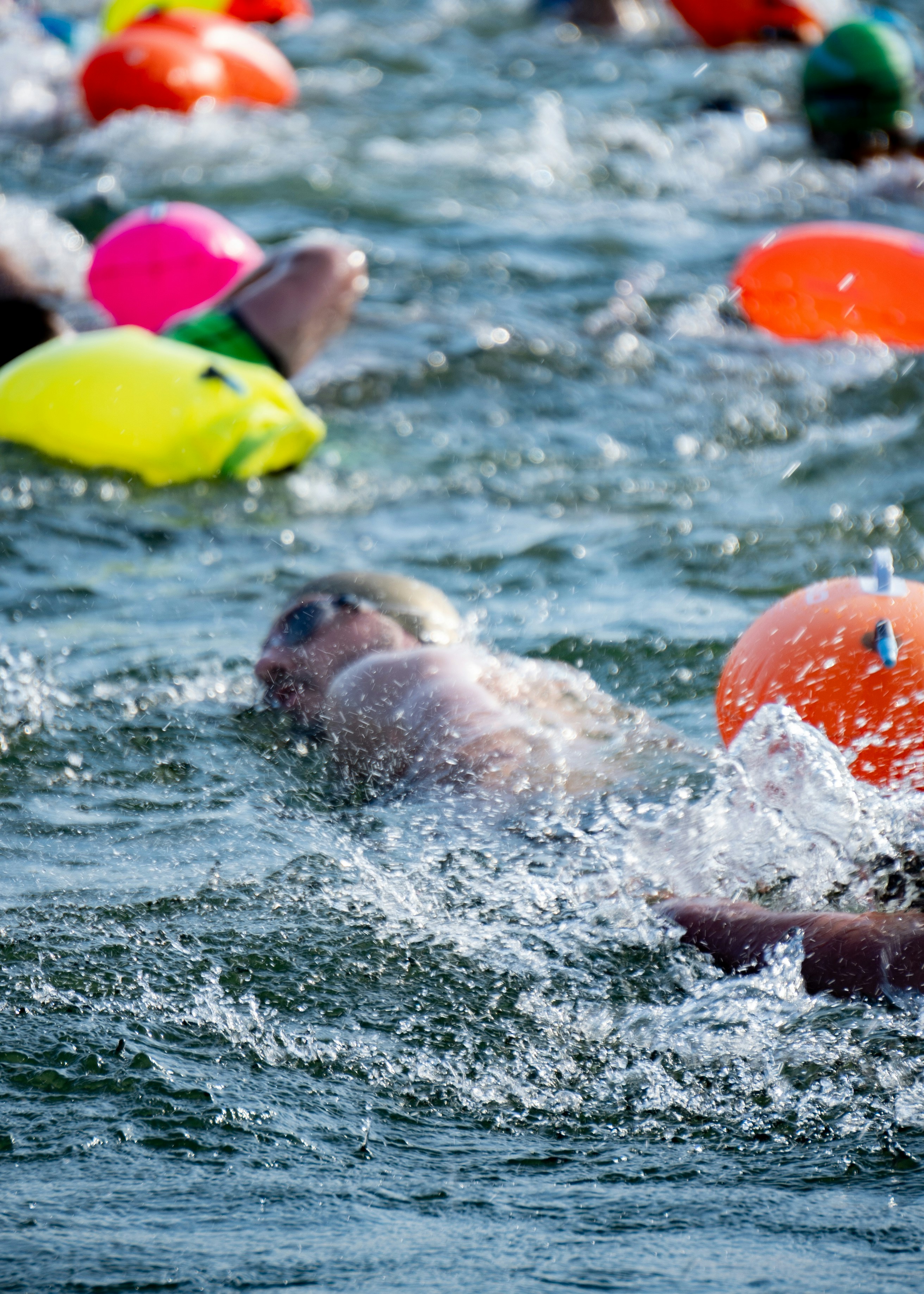 Rush of Colorful Buoys: A Swim Race in Turbulent Water