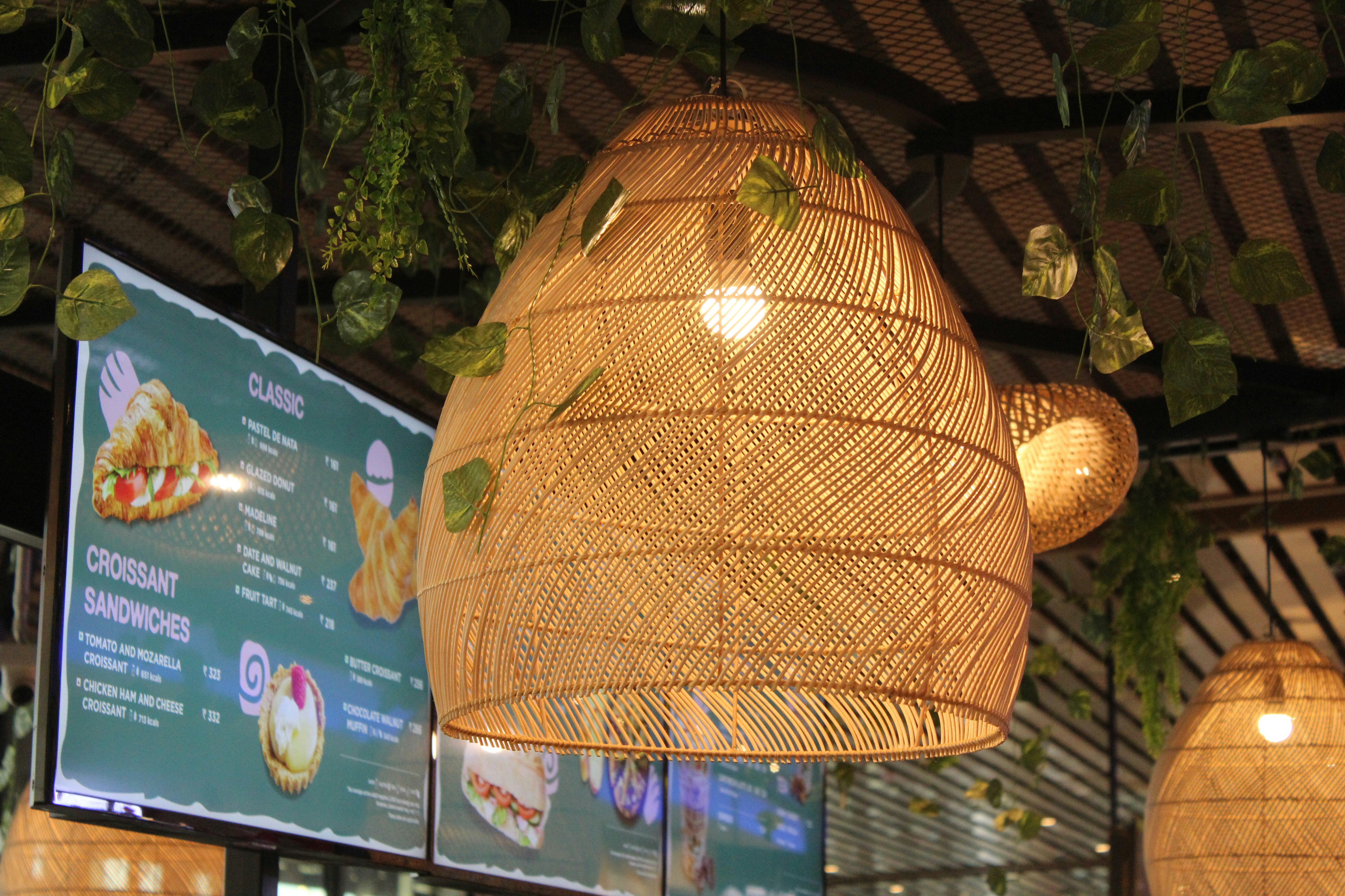 Amber Loom: Woven Lamps Cast Warm Light Over a Modern Café Menu Board