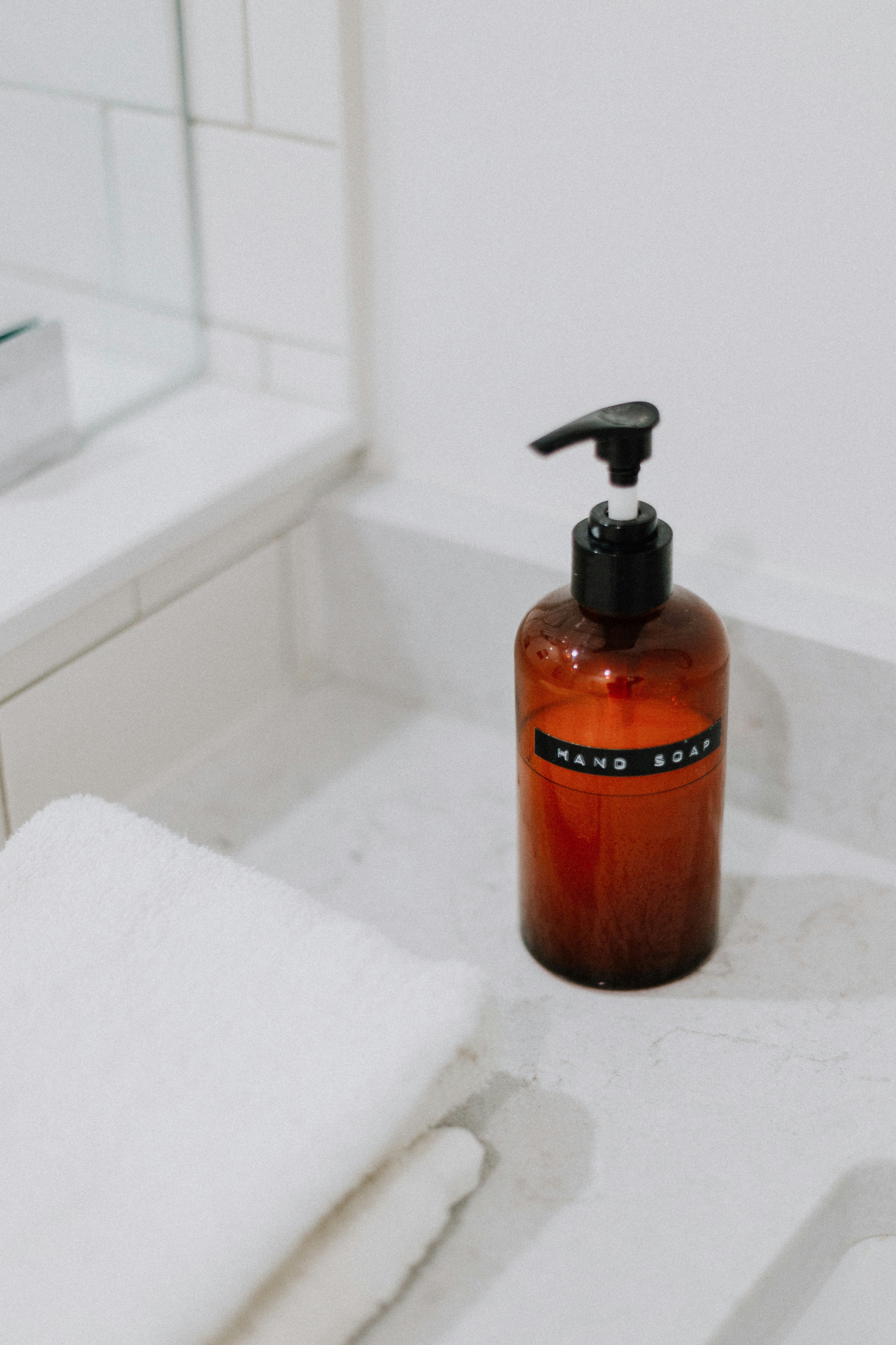 A bottle of soap sitting on a bathroom counter photo – Free Spa Image ...