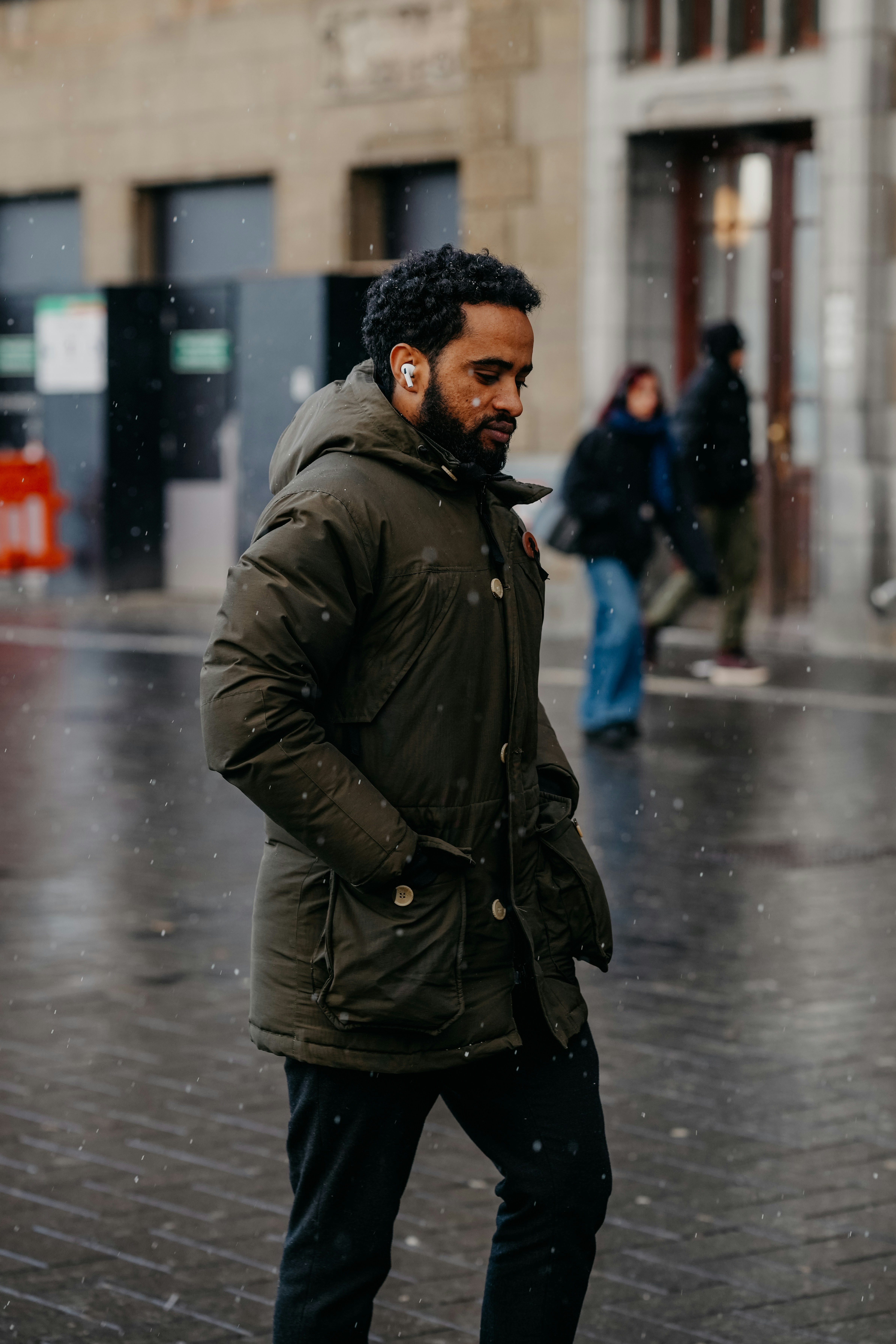 Midtown Snowfall: A Contemplative Walk in Olive Parka