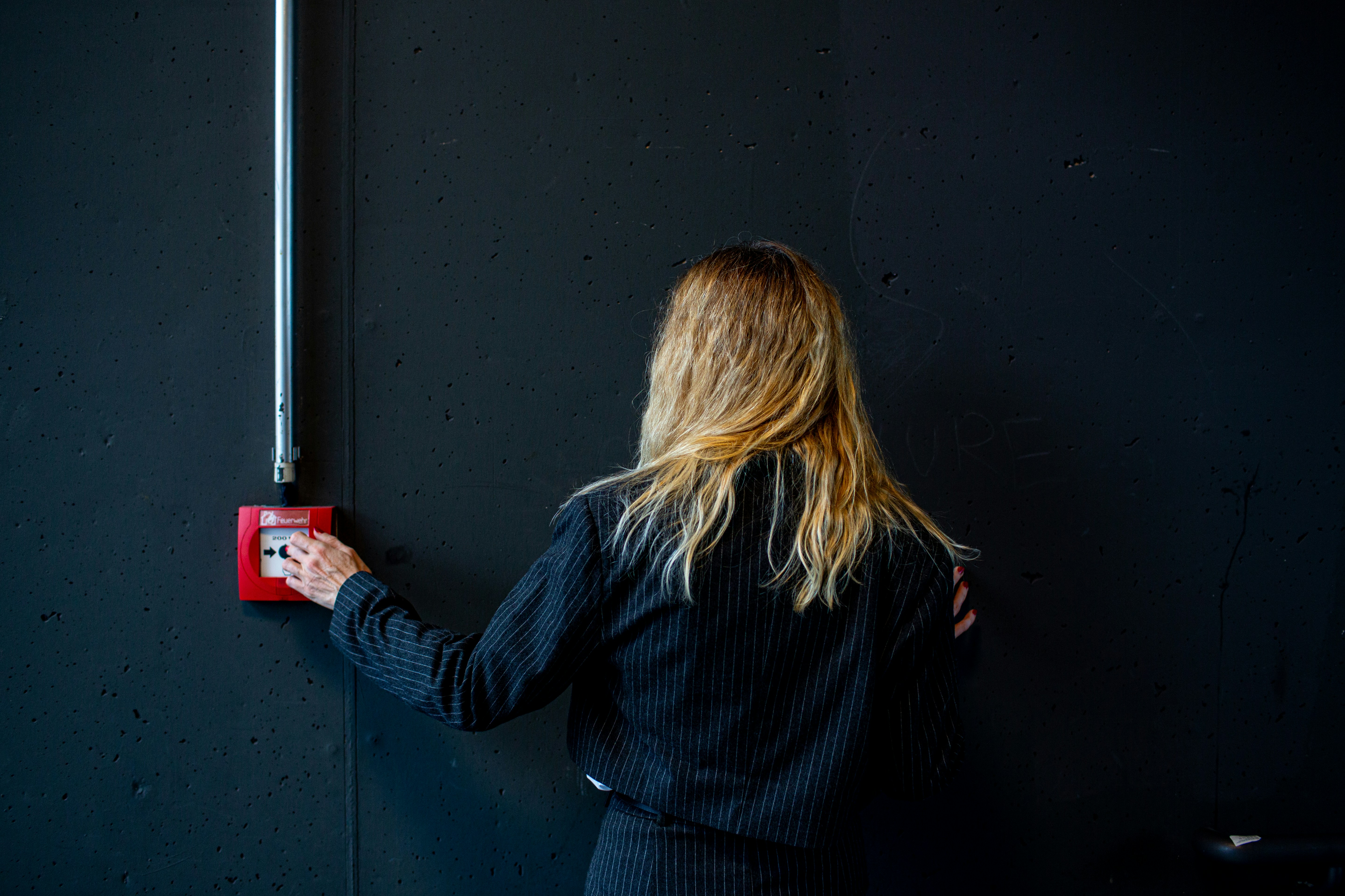 A woman is holding a red light switch photo – Free Woman Image on Unsplash