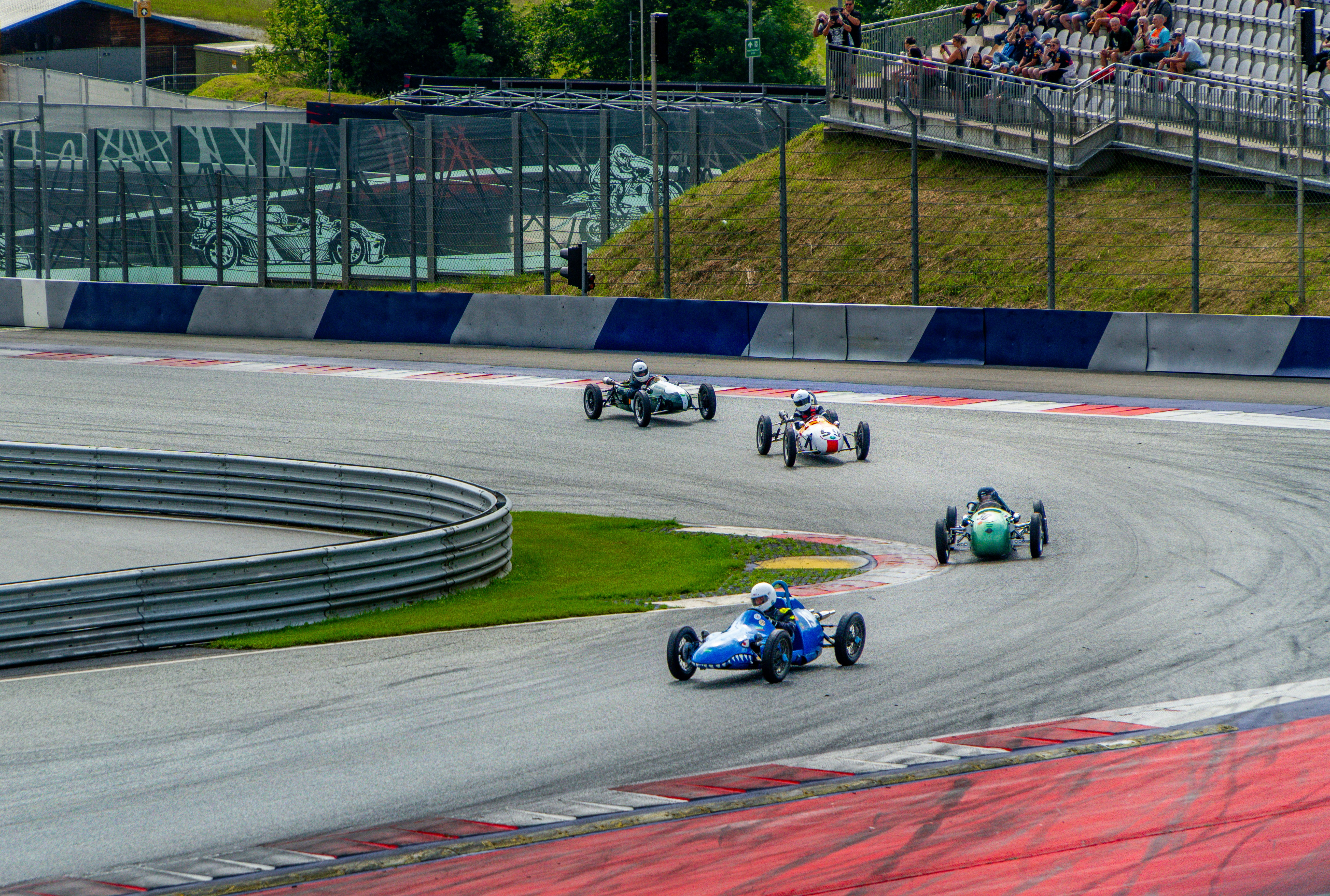 A group of people racing cars around a track photo – Free Red bull ring ...