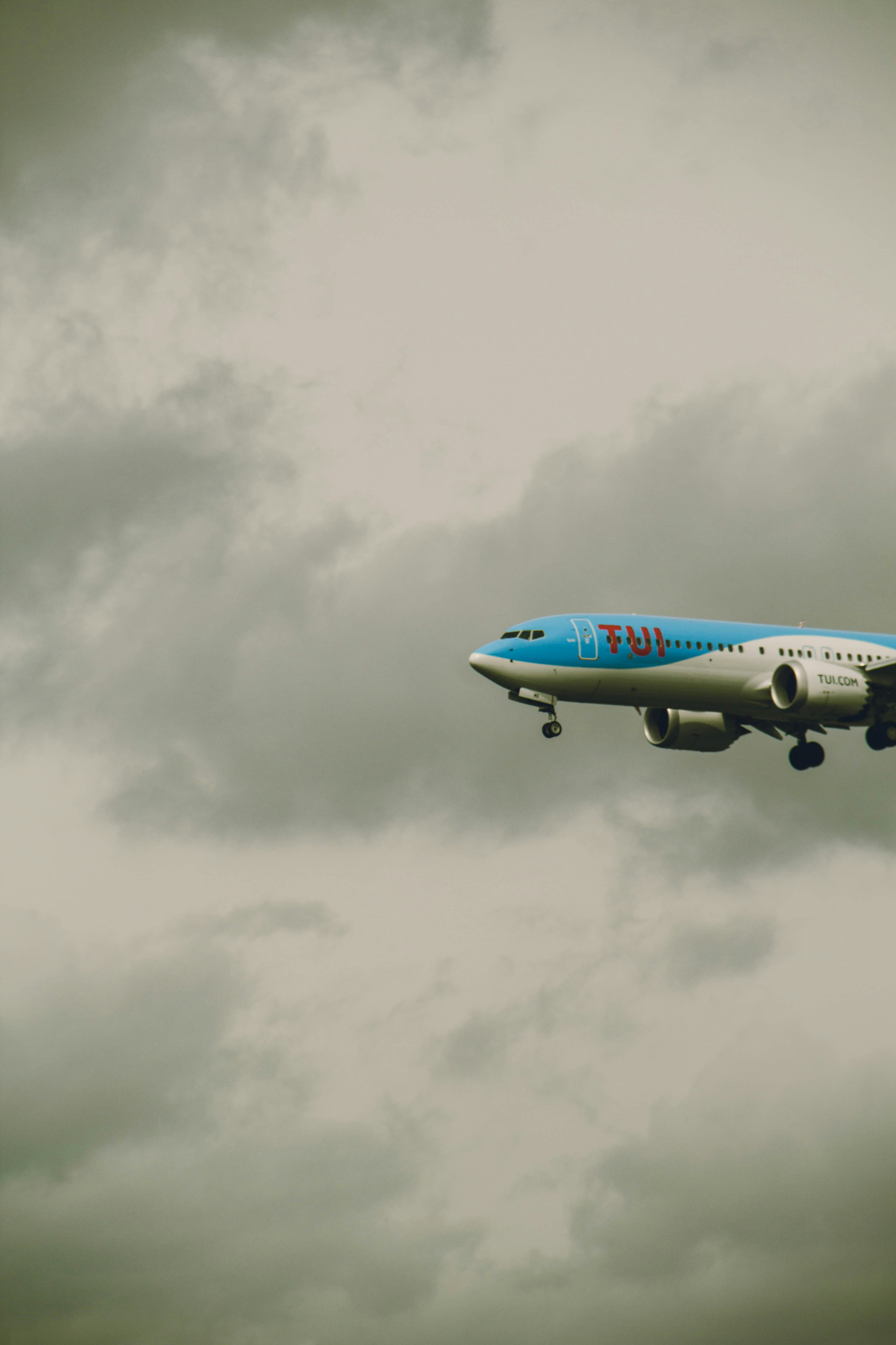 Blue Jet on the Edge: A Quiet Landing Against Clouded Sky