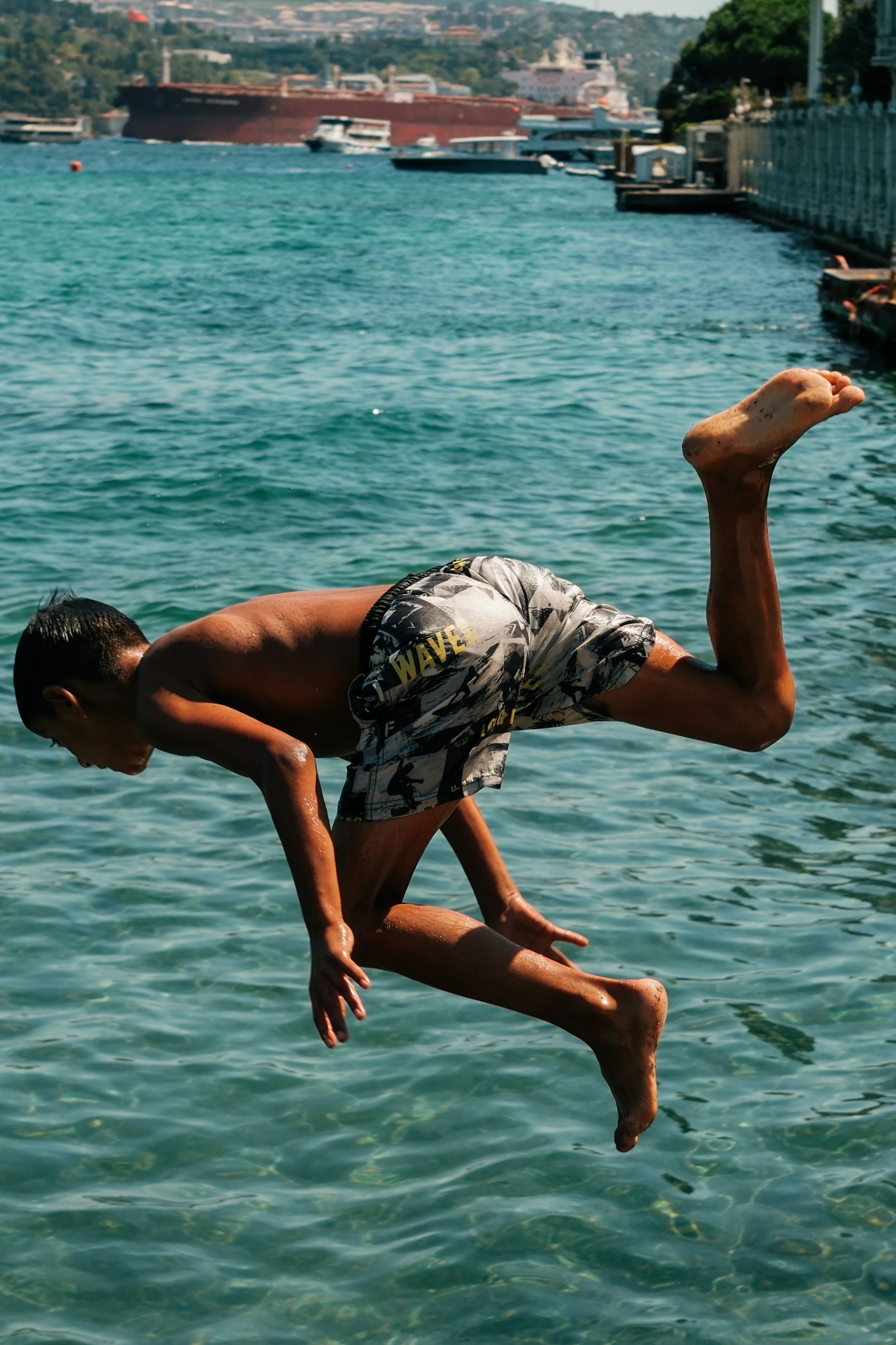 Harbor Leap: Mid-Air Glide Over Turquoise Water