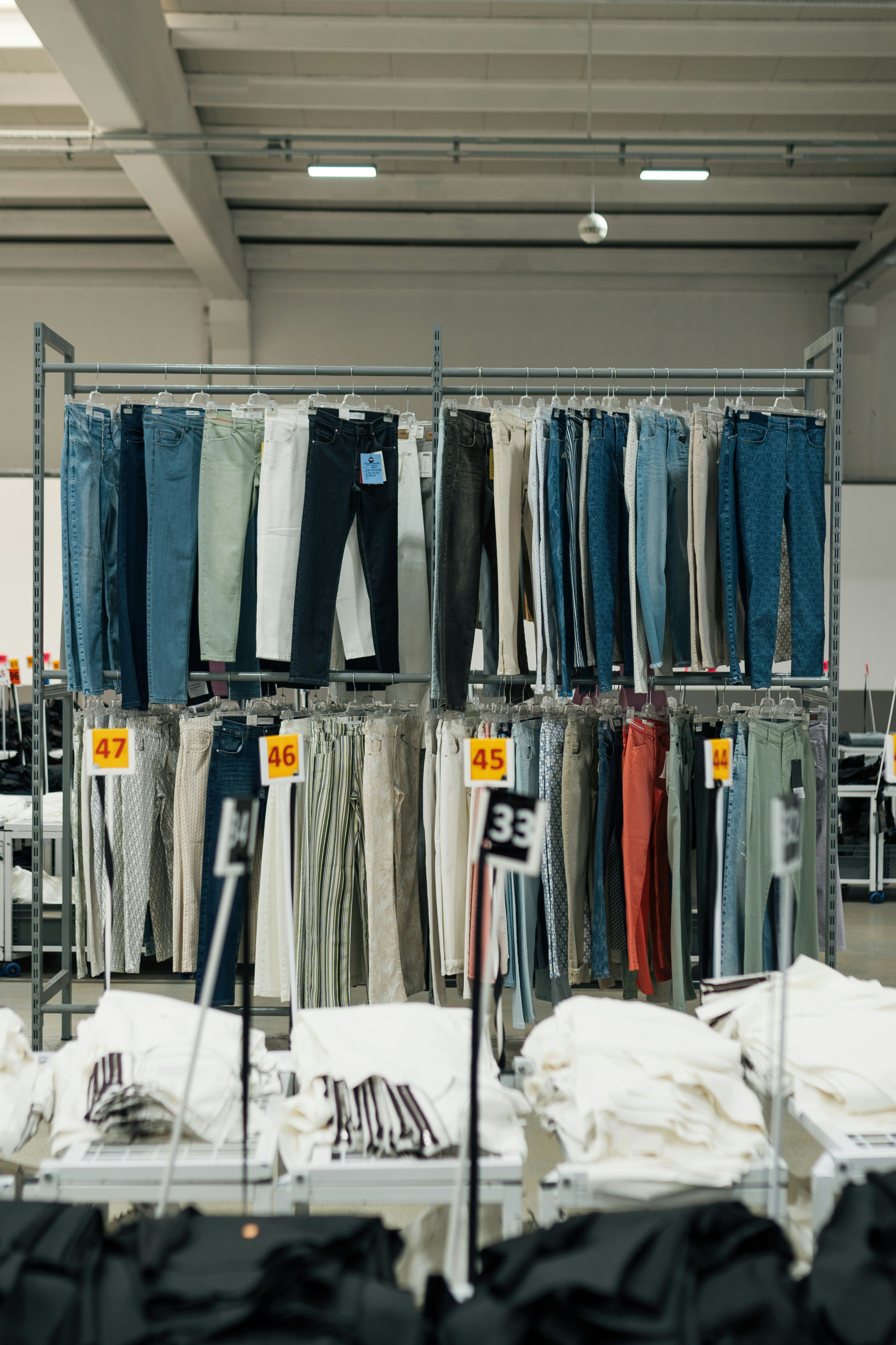 A room filled with lots of different colored pants photo – Free ...