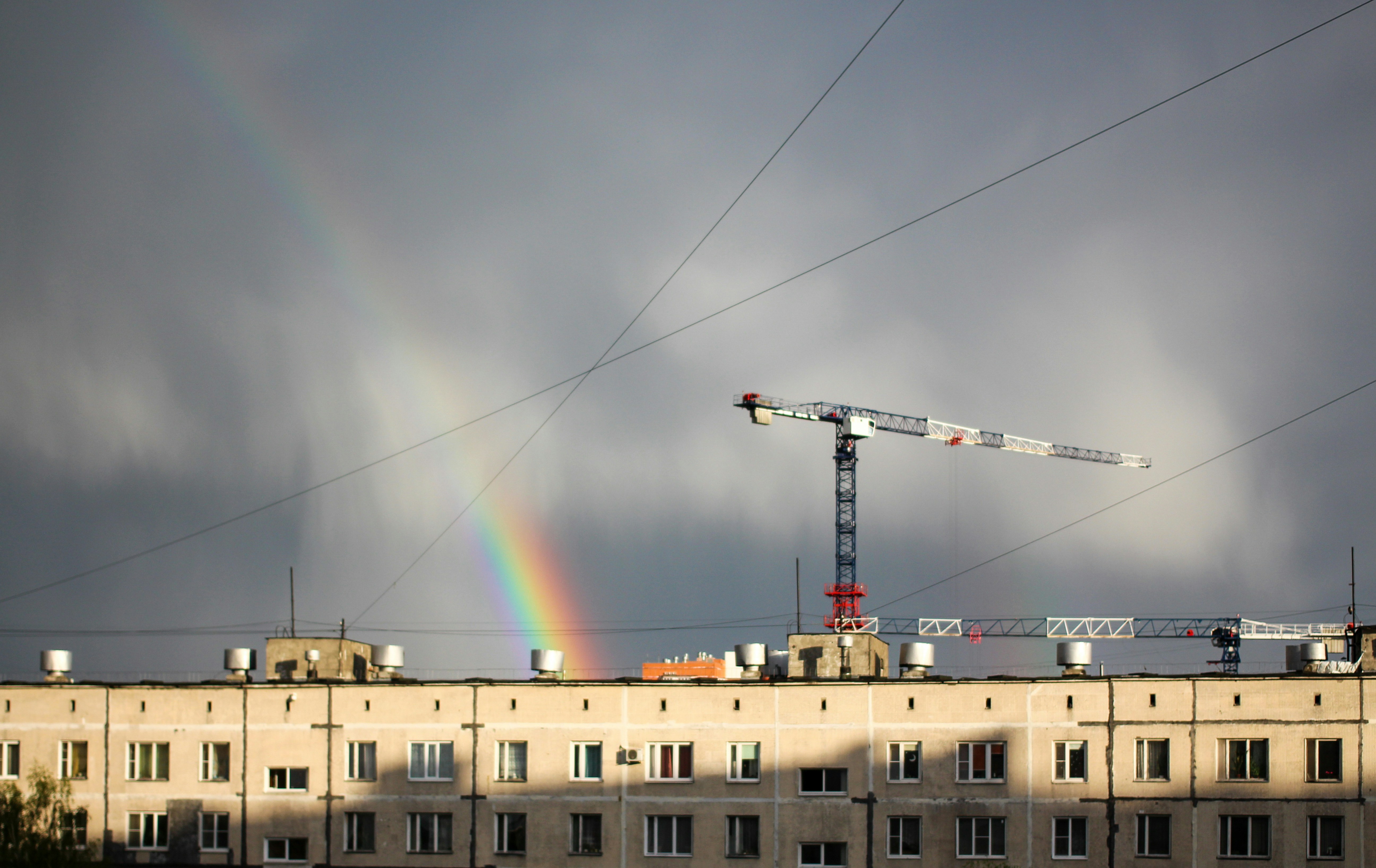 A large building with a rainbow in the background photo – Free Moscow ...