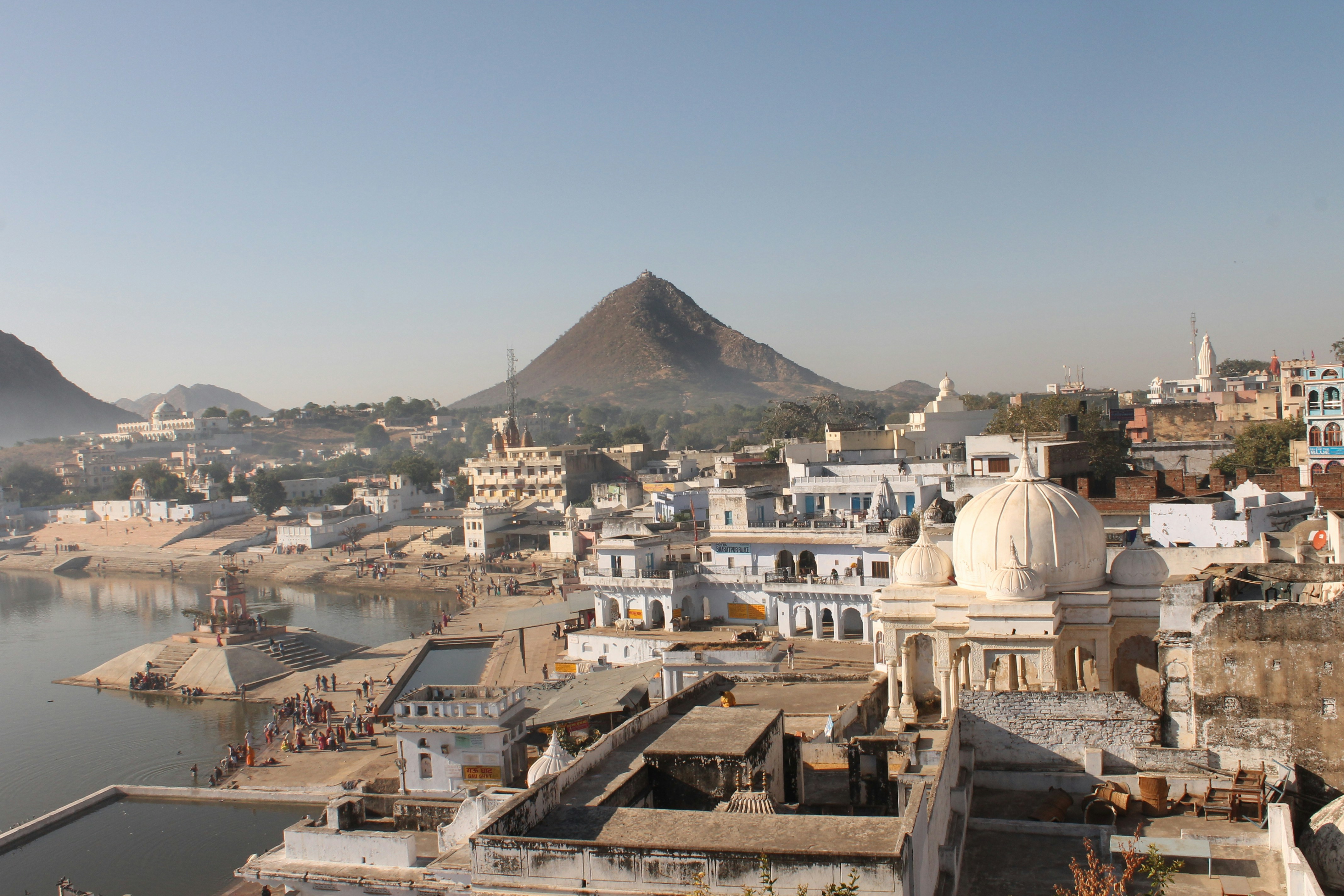 White Domes by the River: A Ghats City Framed by a Lone Peak