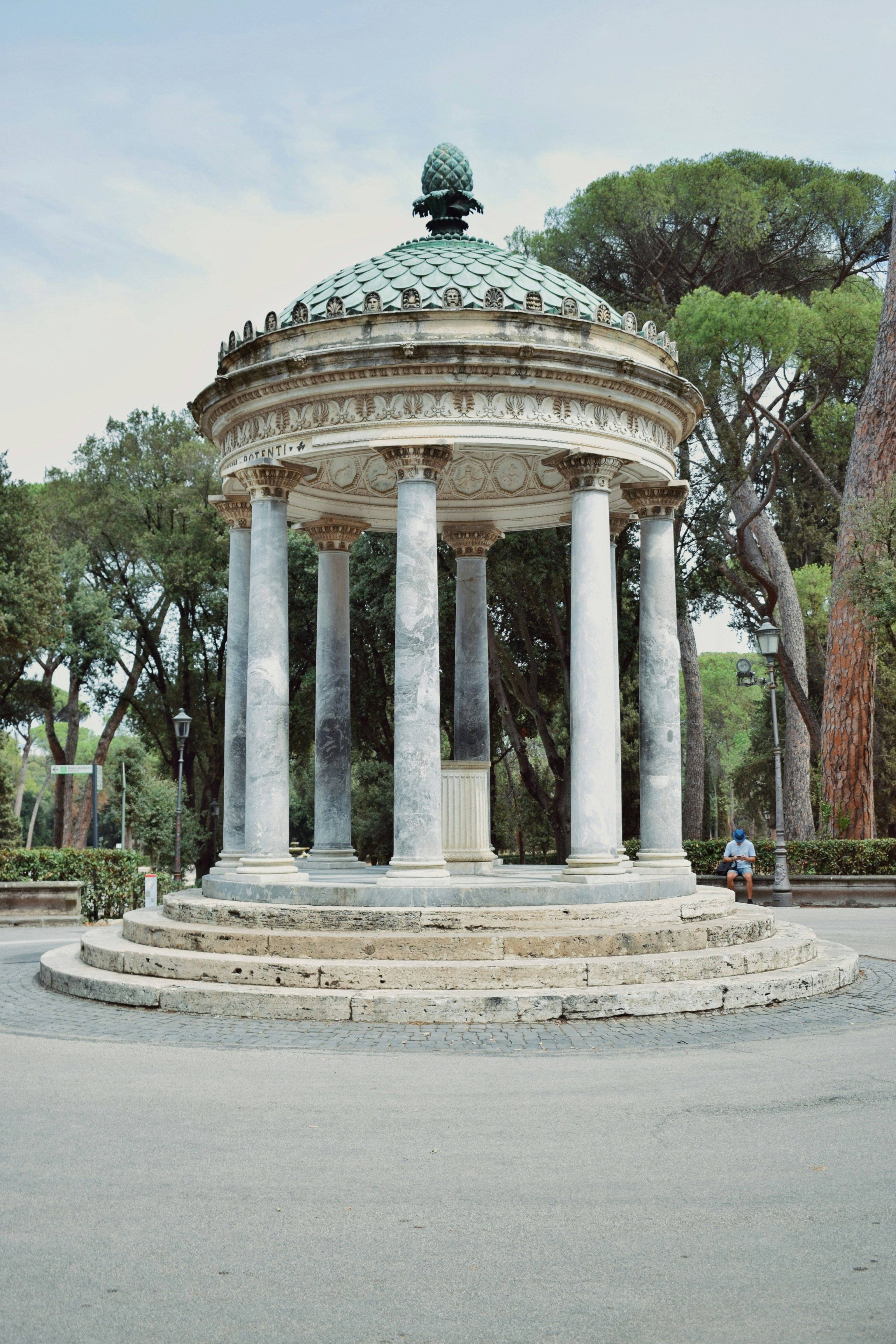 A small stone structure with columns in a park photo – Free Rome Image ...